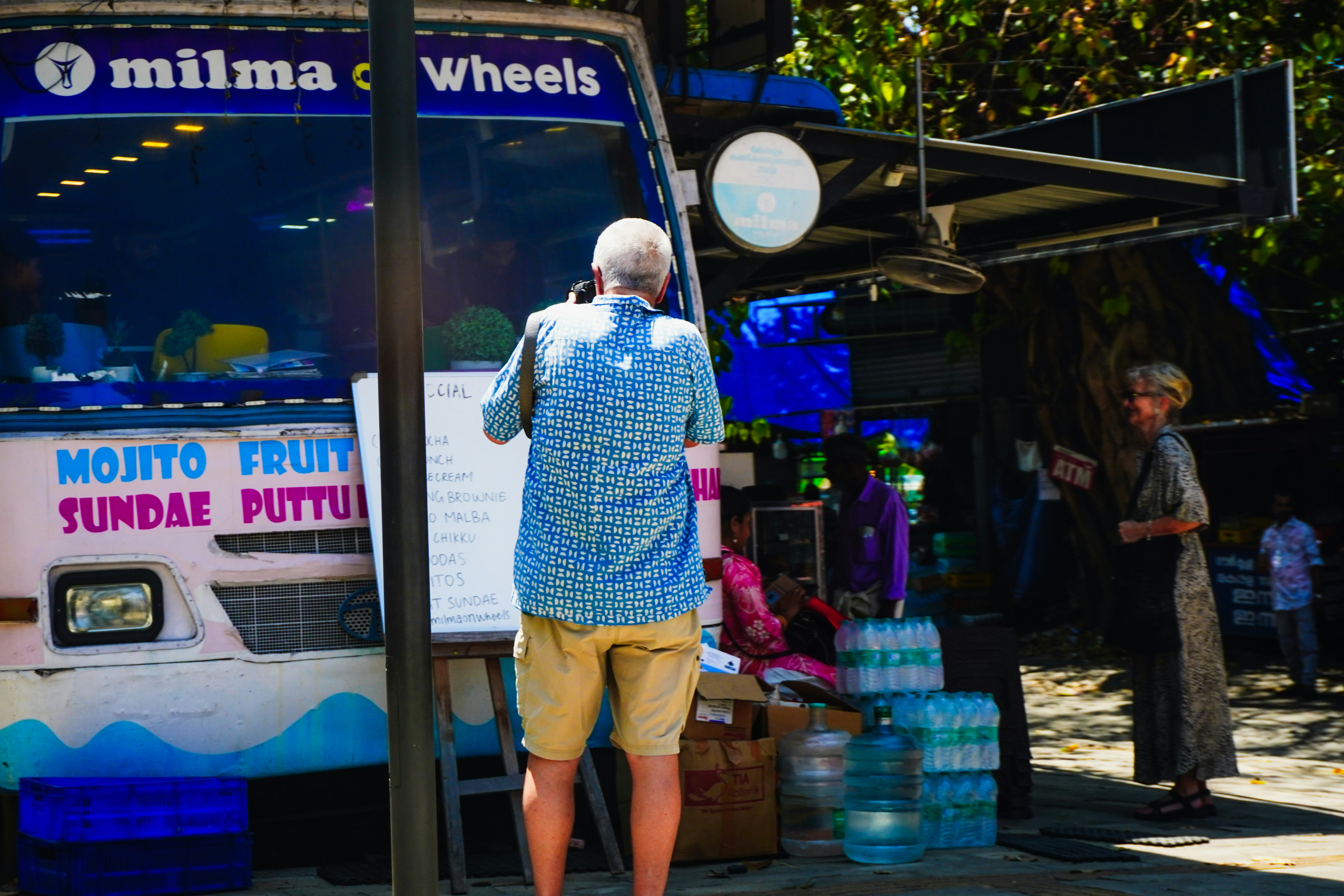 Street Vendor Portrait: Elderly Photographer Captures the Snack Stand Scene