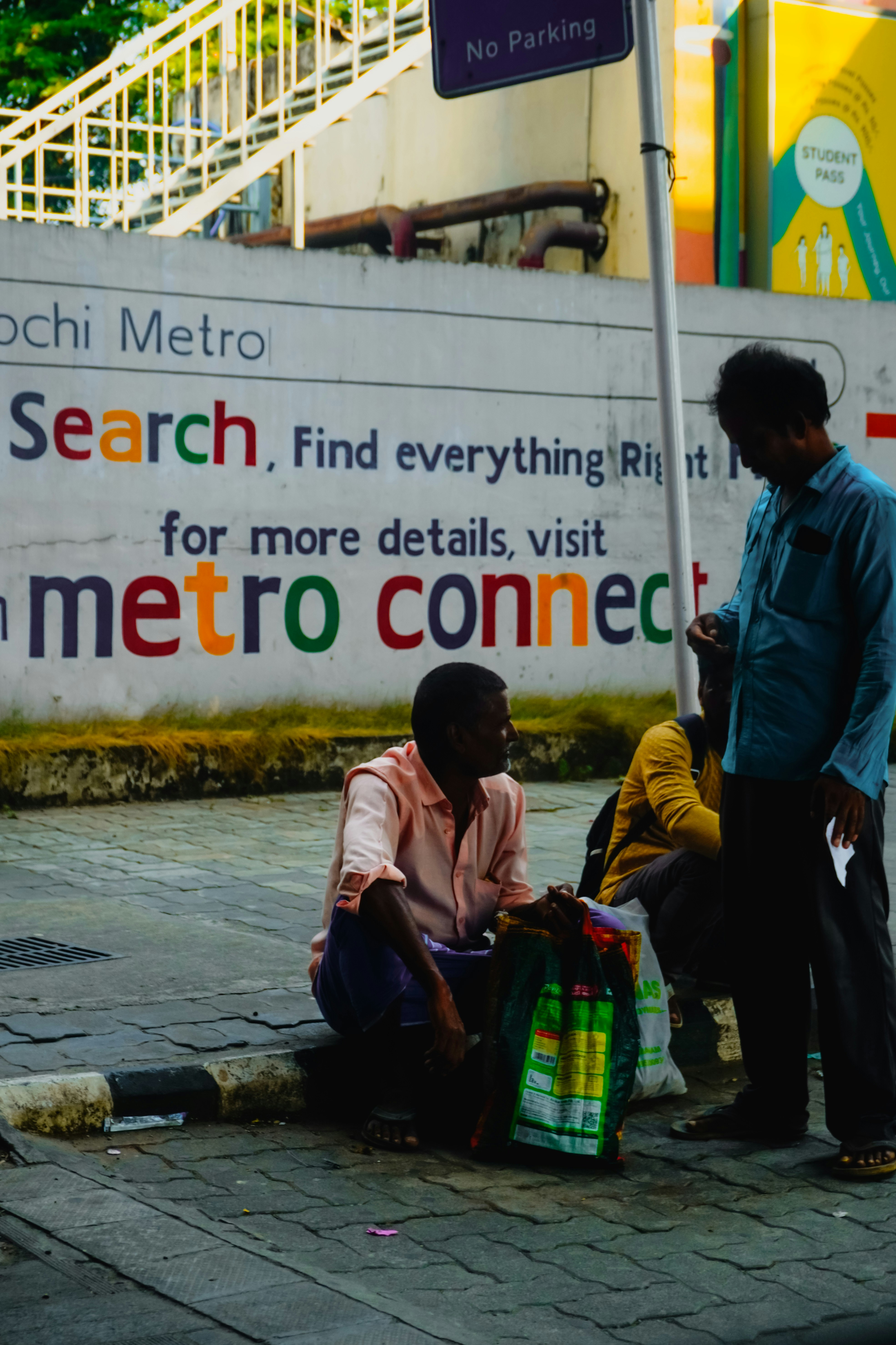 Street-side Chat Under a Metro Wall