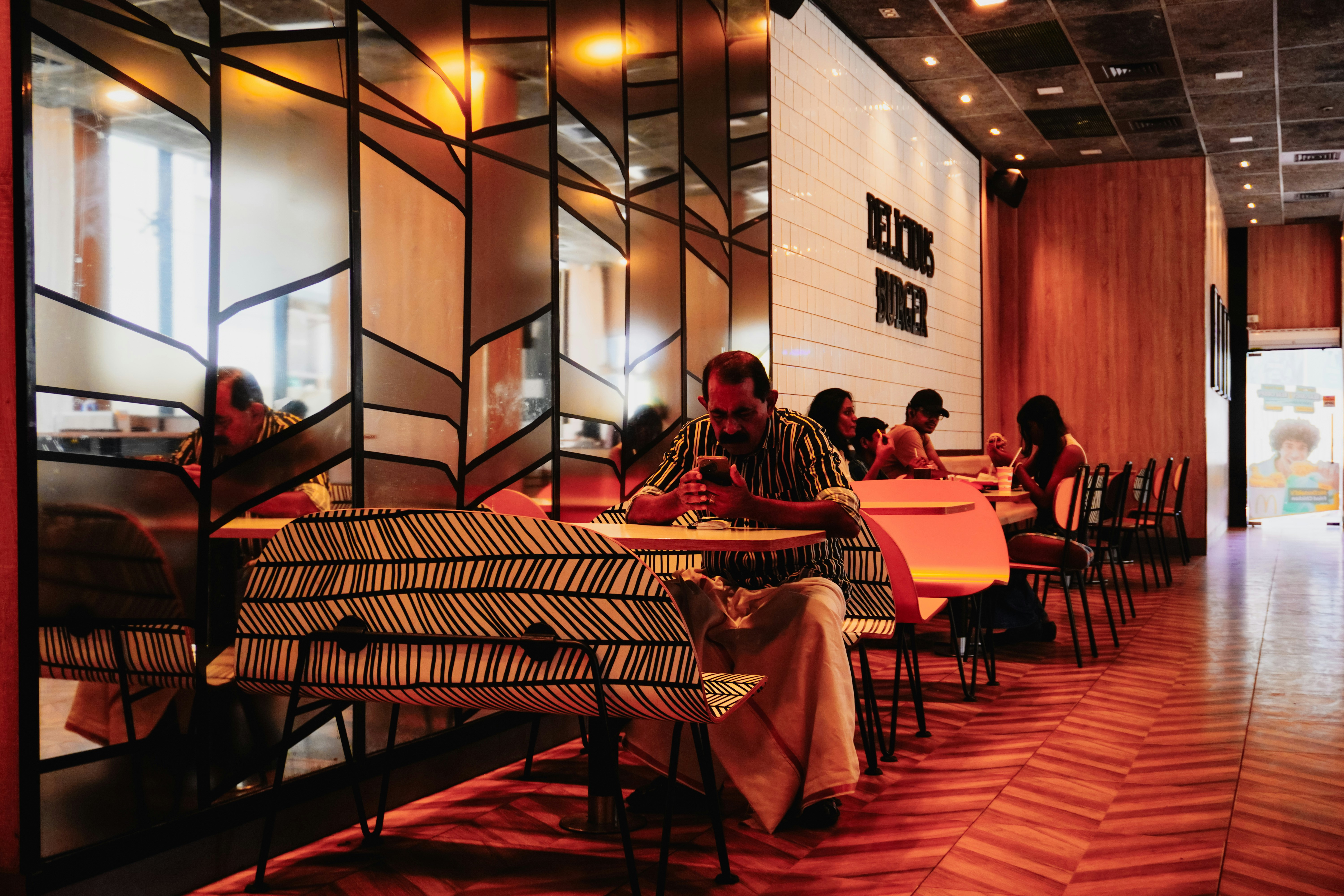 Quiet Intimacy at a Modern Café: Stripes, Glass, and Warm Light