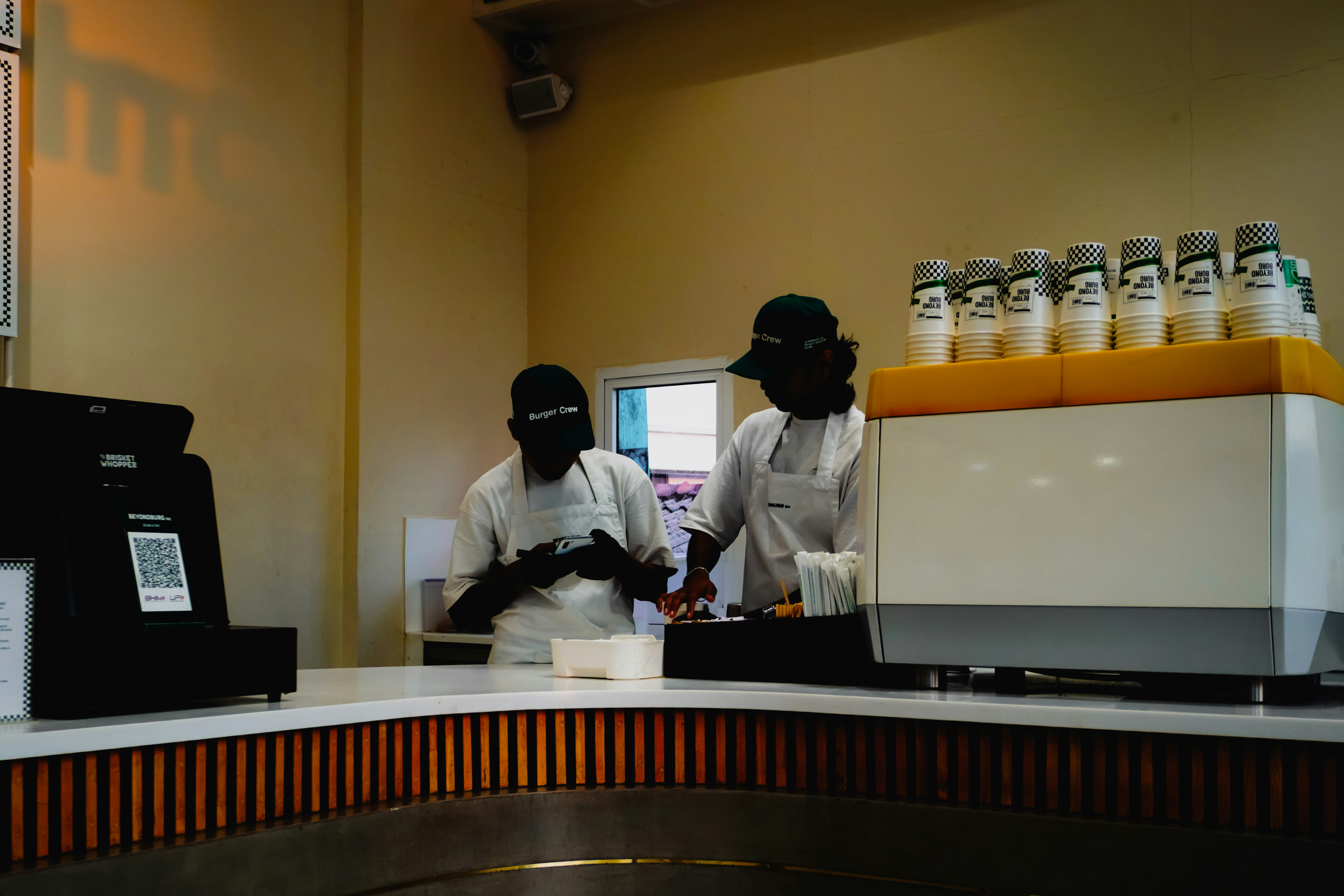 Behind the Counter: Baristas in White Aprons at a Minimal Cafe