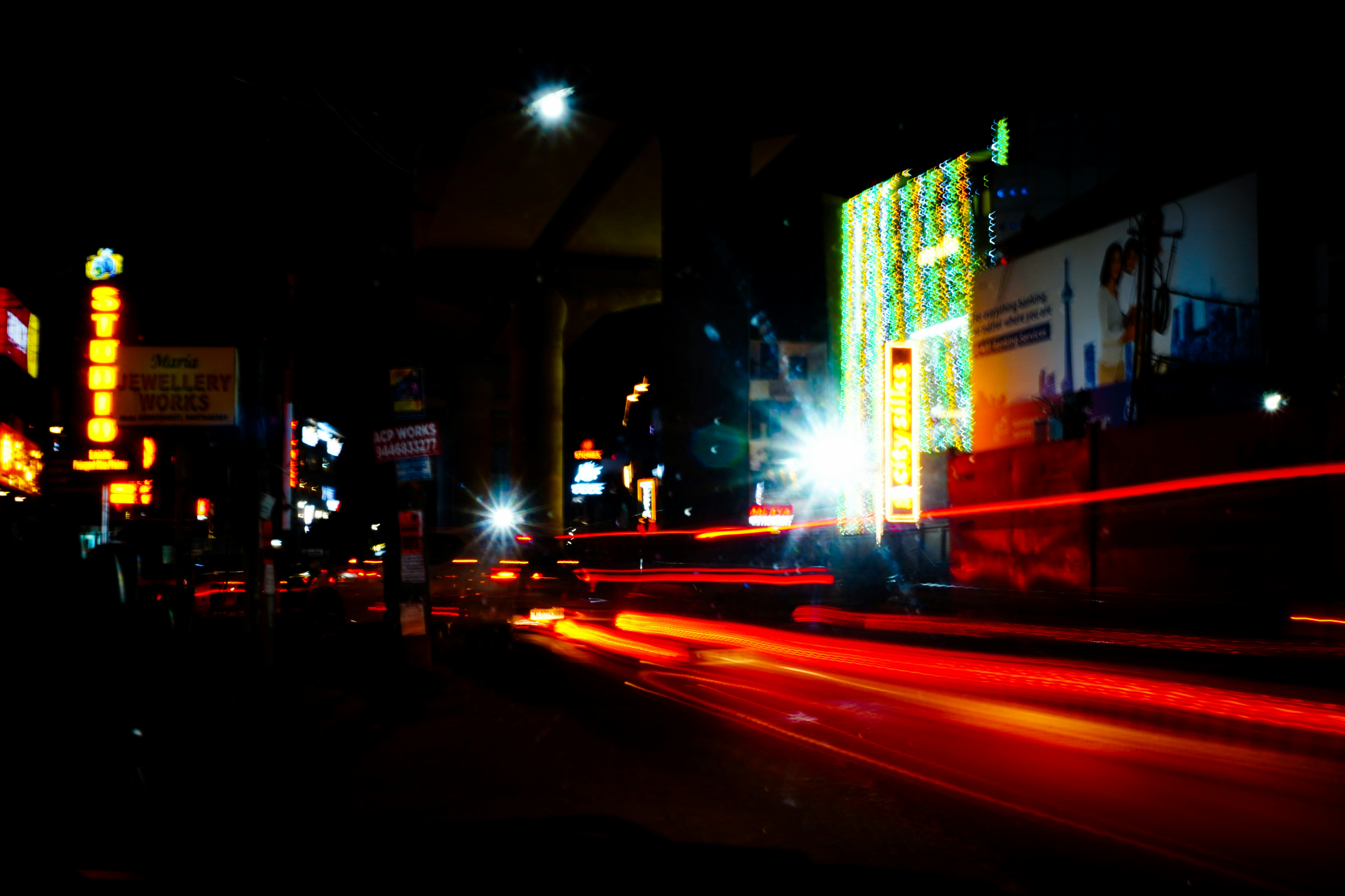 Neon Trail Through Night Street