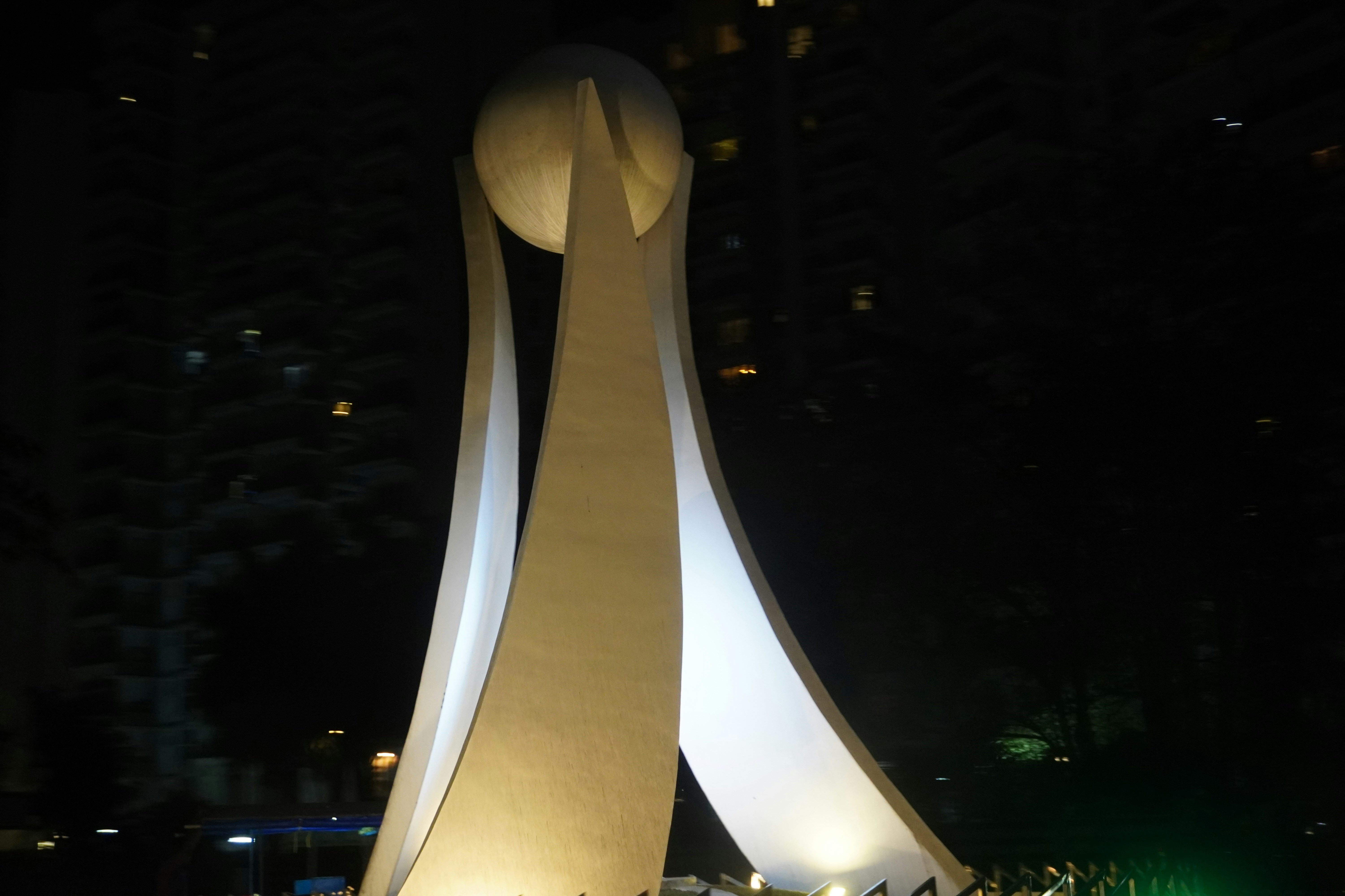 Urban Monument at Night: The Sculpted Arc and Globe