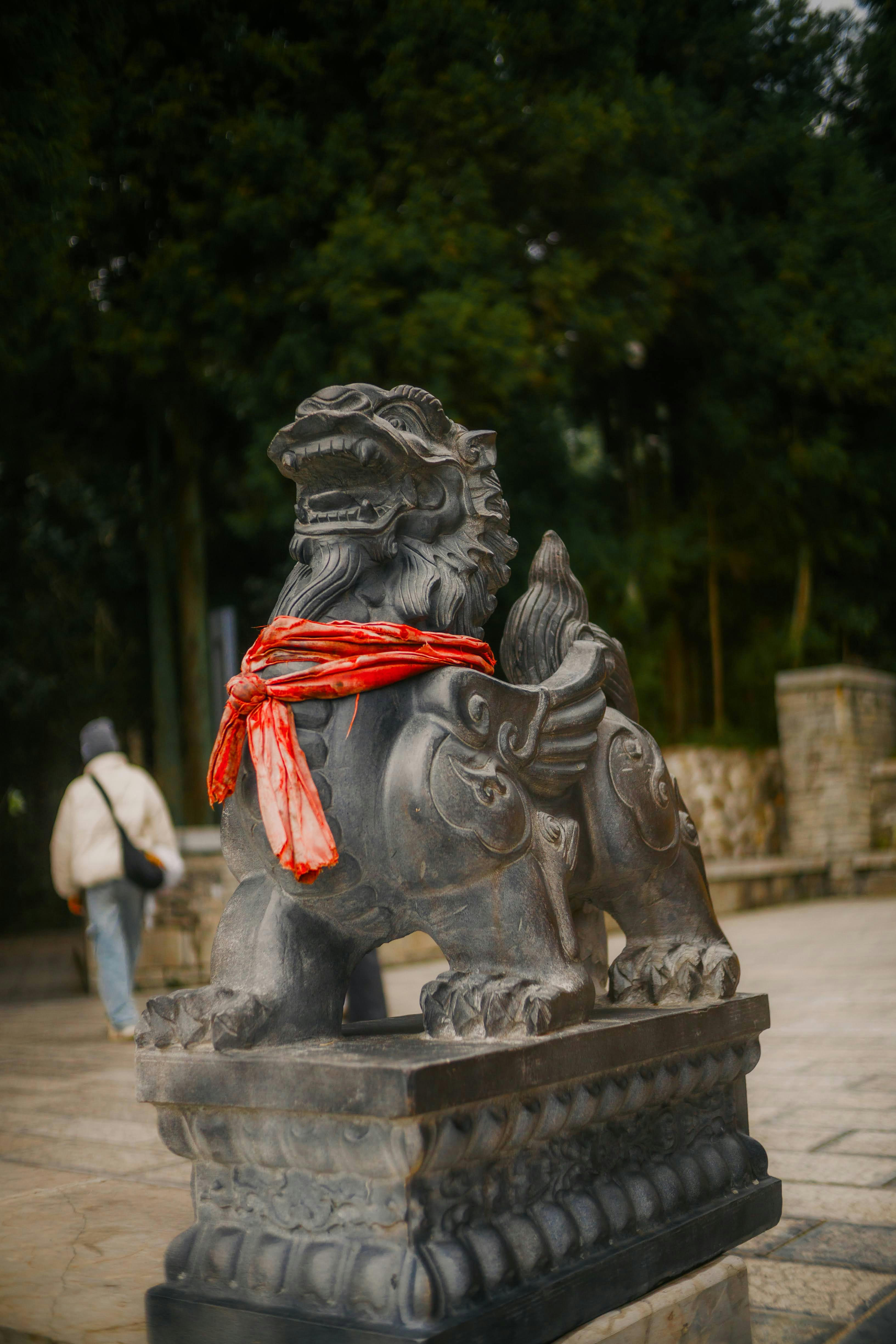 Stone Guardian with Red Scarf: A Silent Sentinel at the Courtyard Gate
