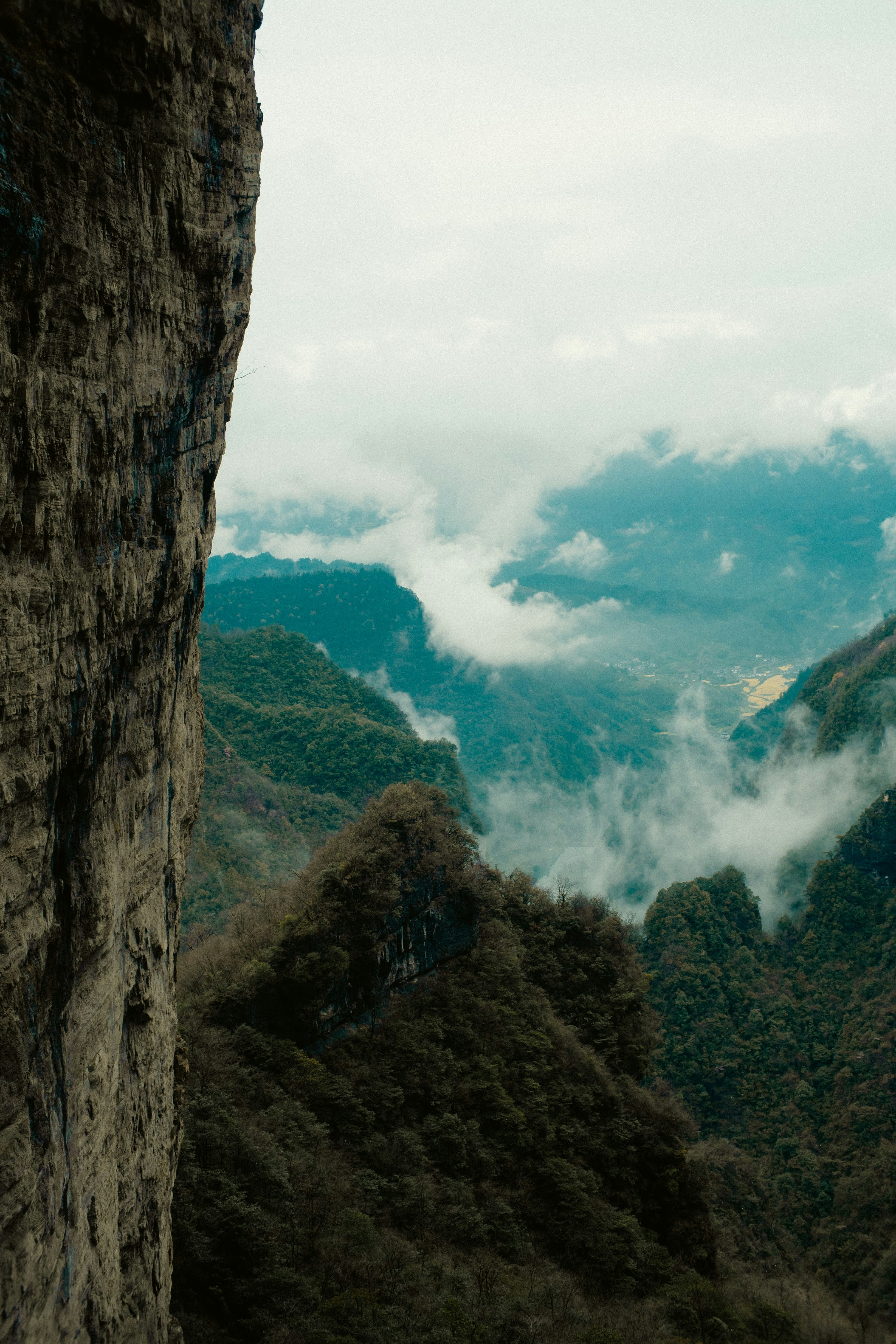 Sheer Cliff Edge Over a Valley of Clouds