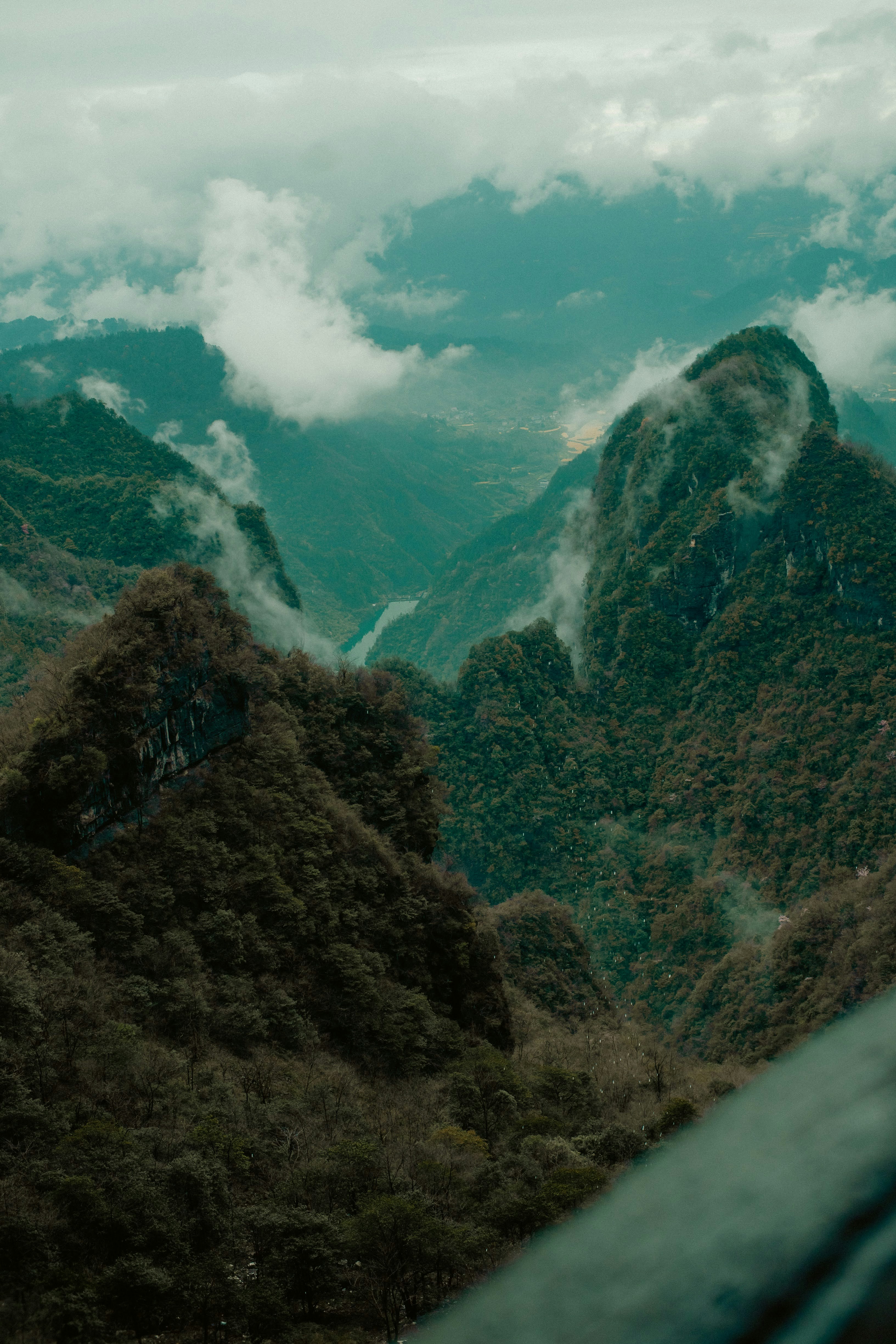 Mist Shrouded Gorge: River Winding Between Cloud-Crowned Peaks