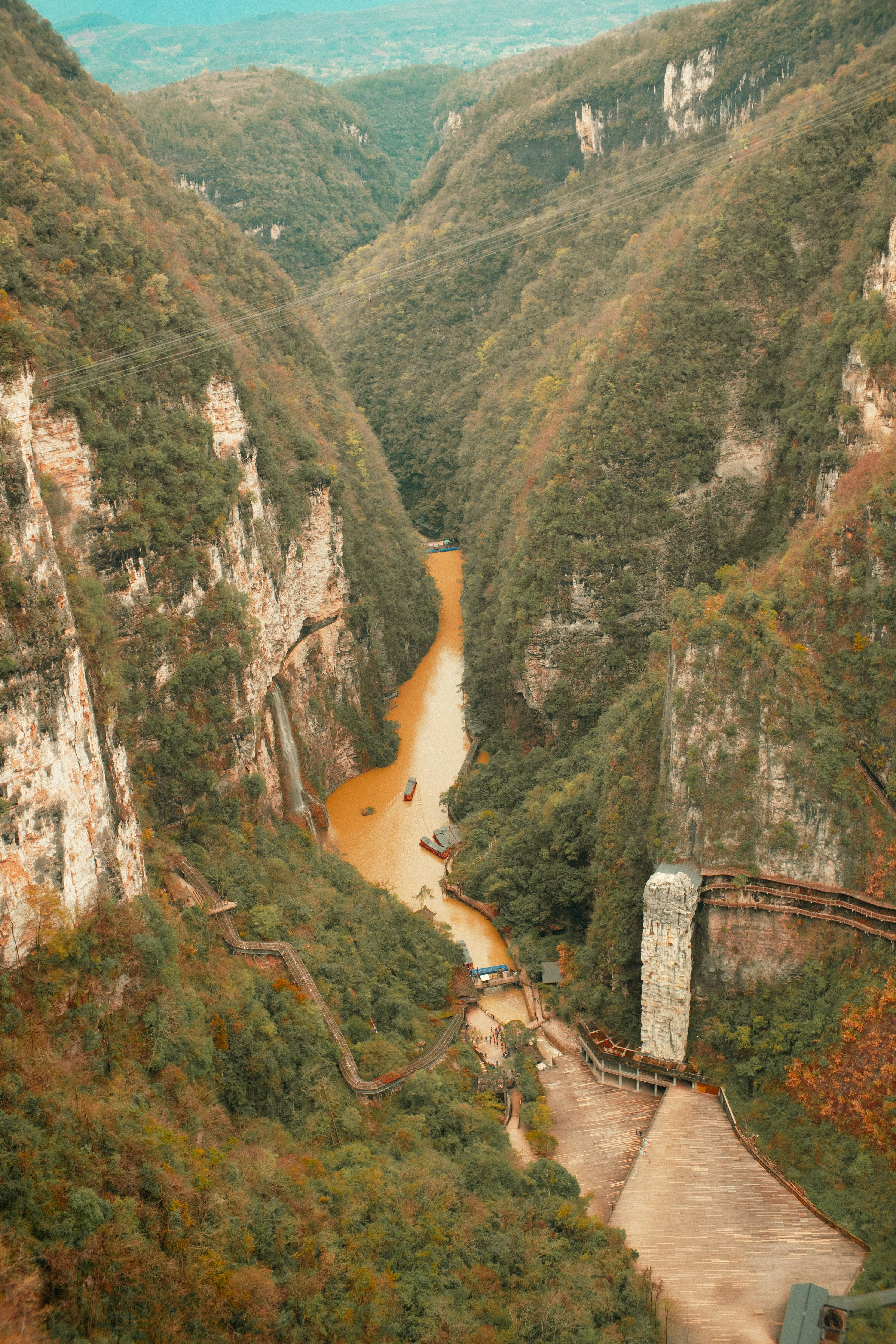 Aerial Vessel Carving Through Autumn Gorge