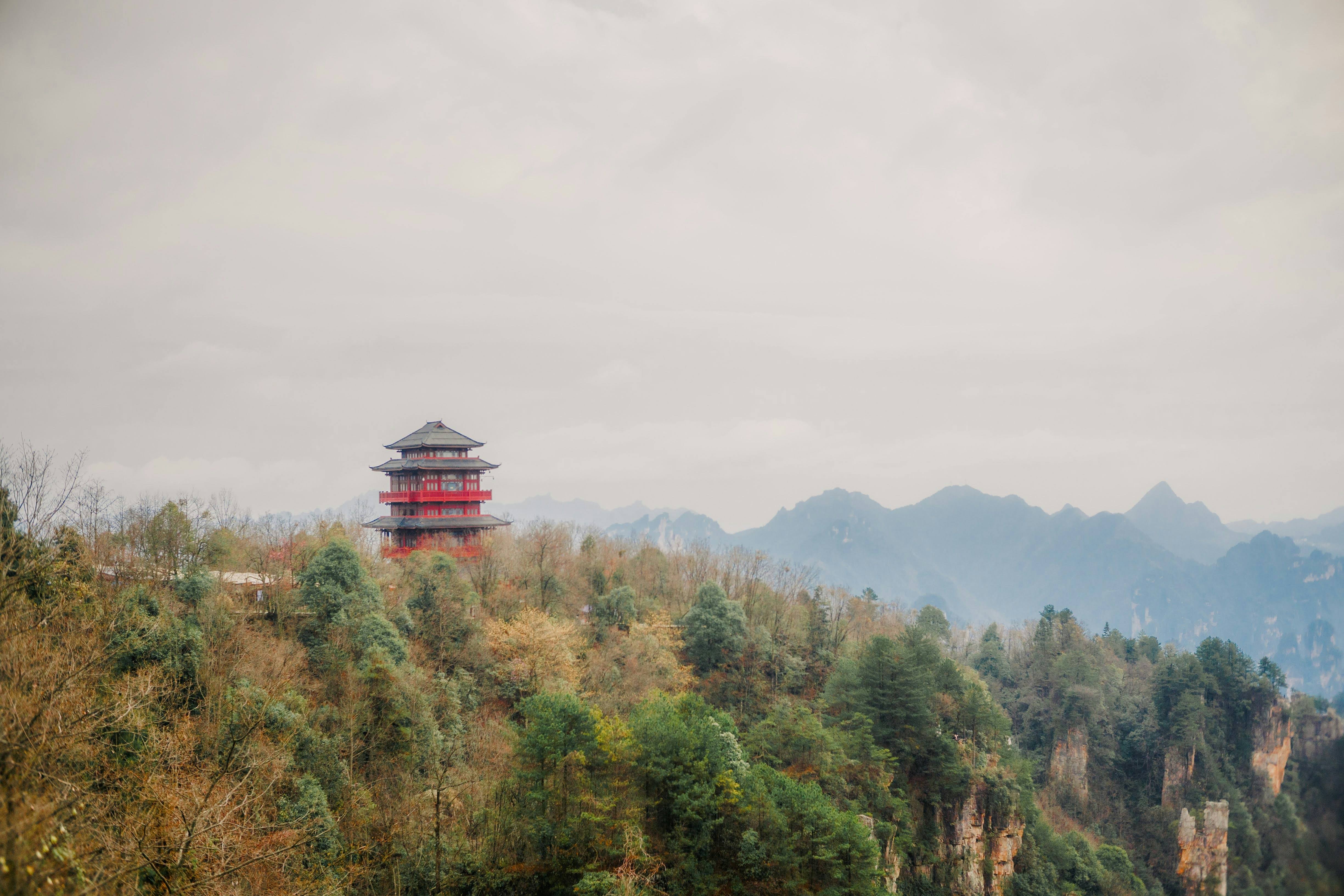 Red Pagoda on the Ridge: Autumn Mist Over the Valley
