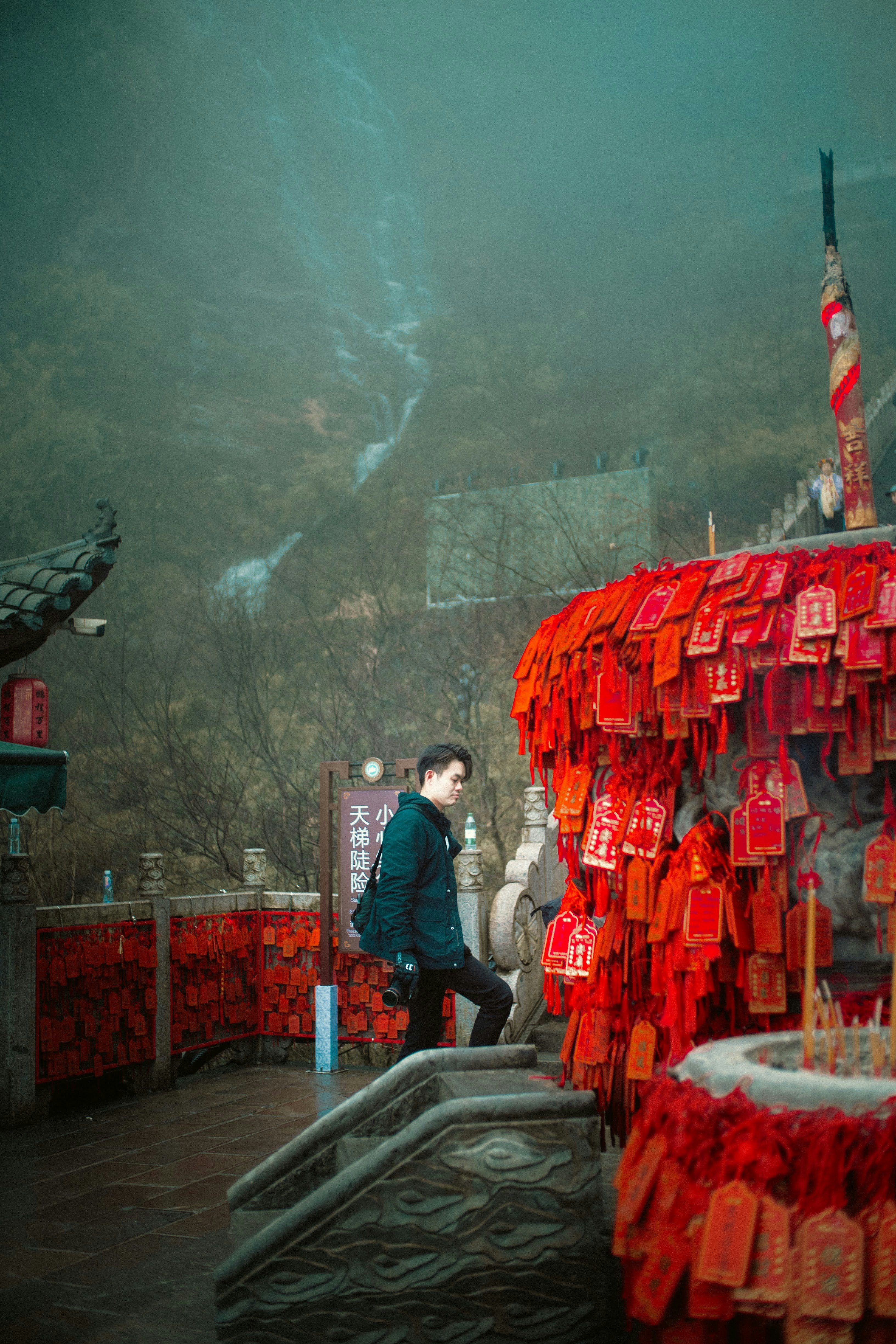 Traveler in Red-Ribboned Urban Shrine