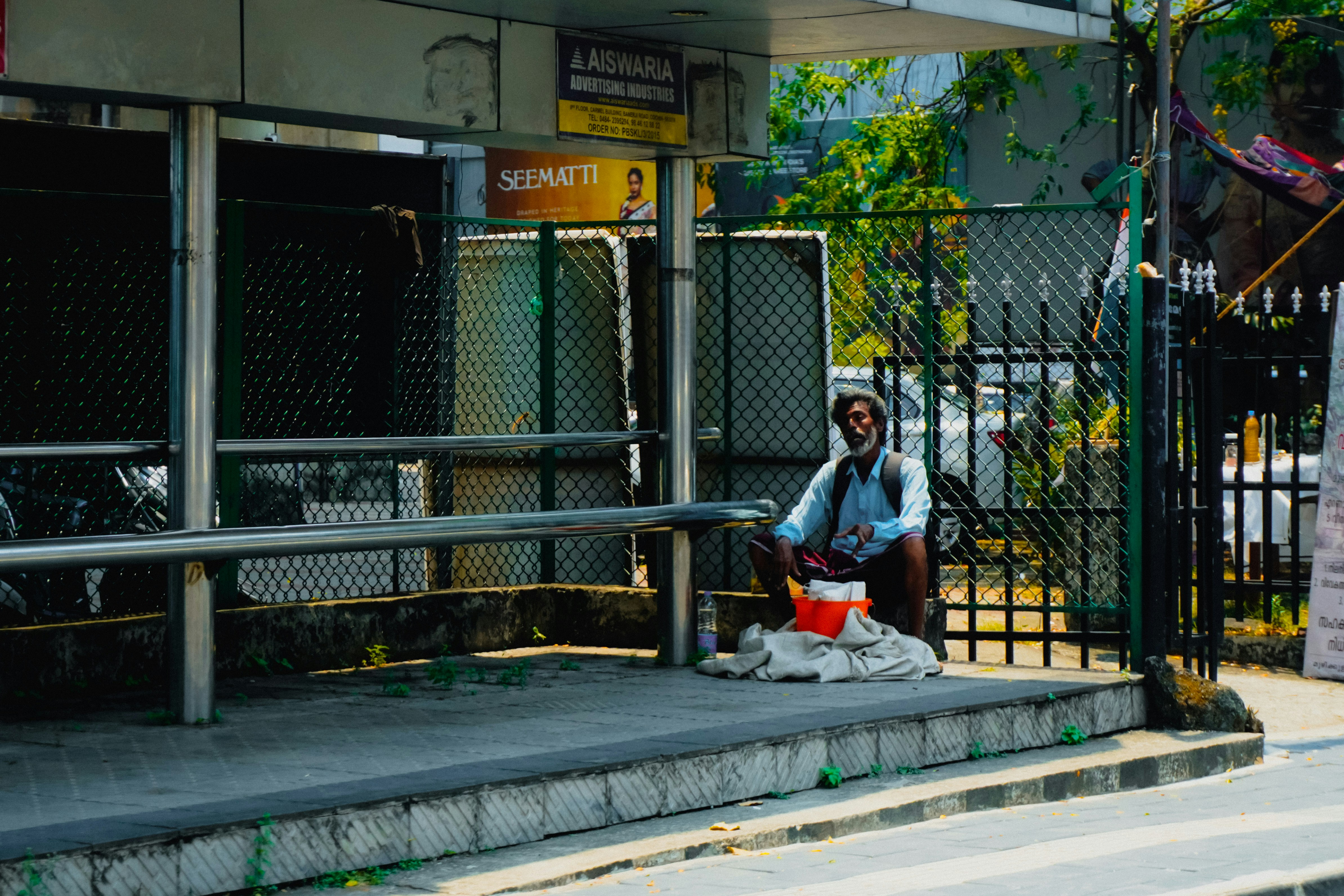 Weathered Busk Stop: A Quiet Street Portrait with a Solo Vendor