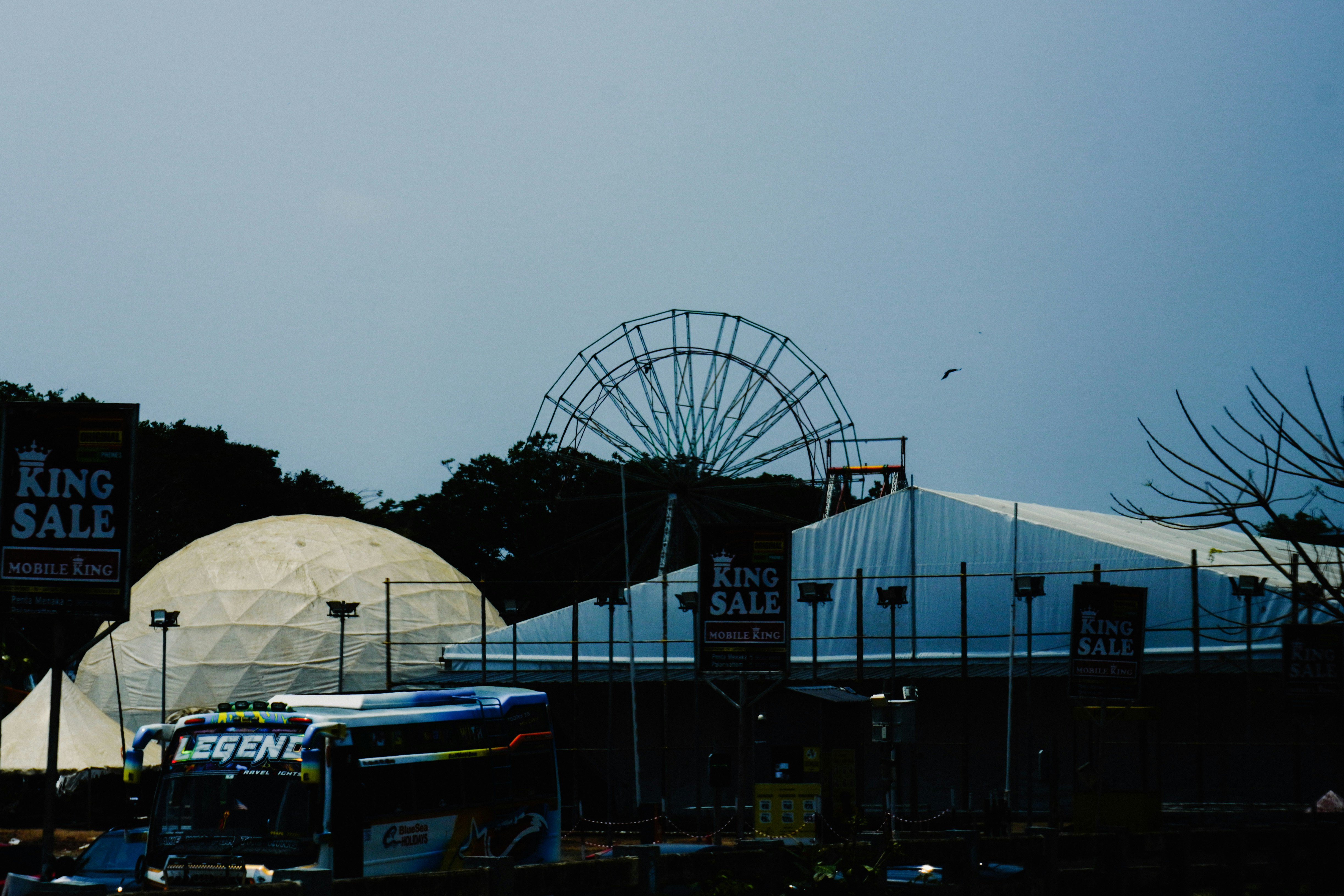 Ferris Wheel Silhouette Over Industrial Expo