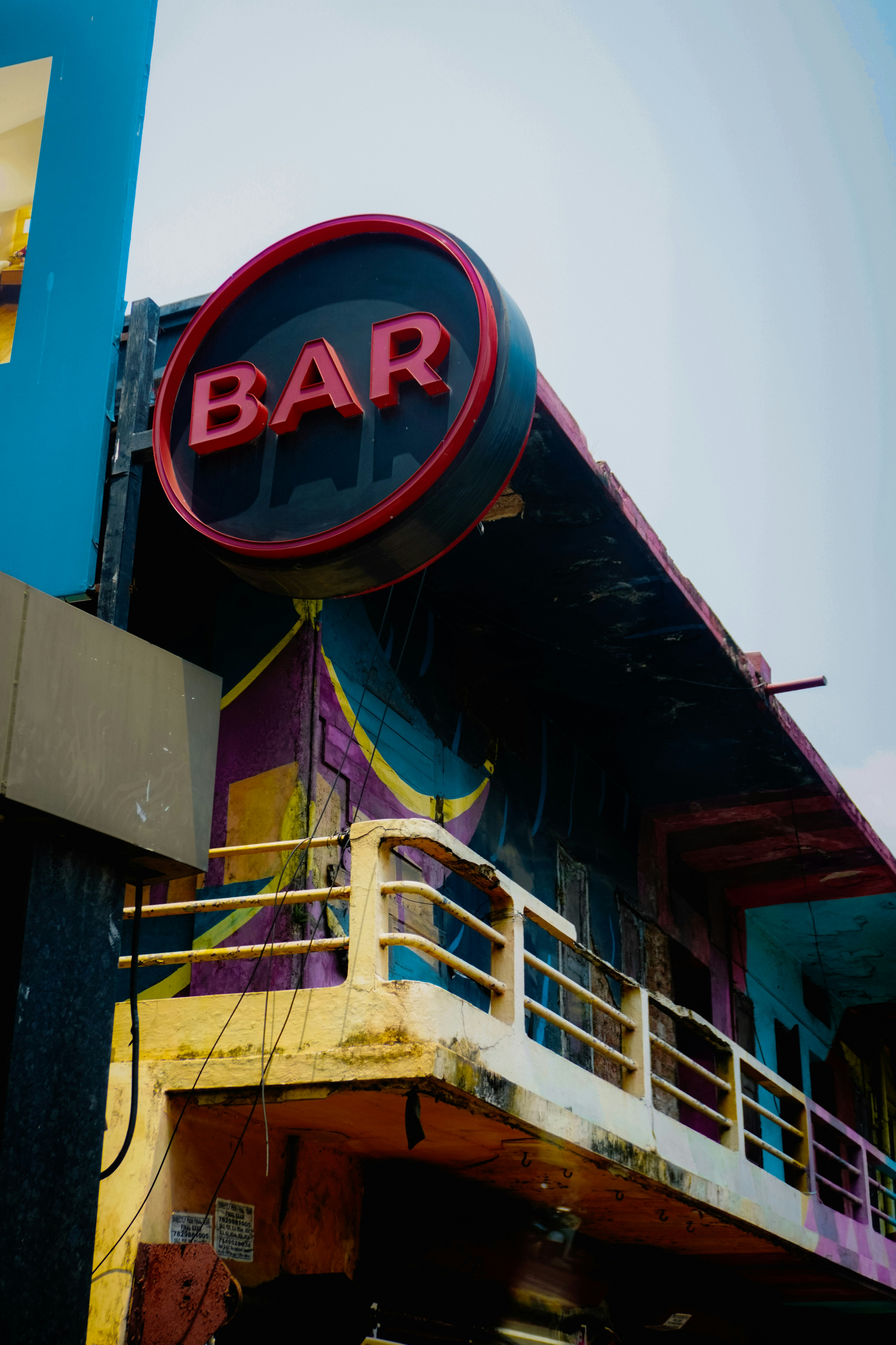 Neon Bar Sign Overlooking a Colorful Open-Air Venue