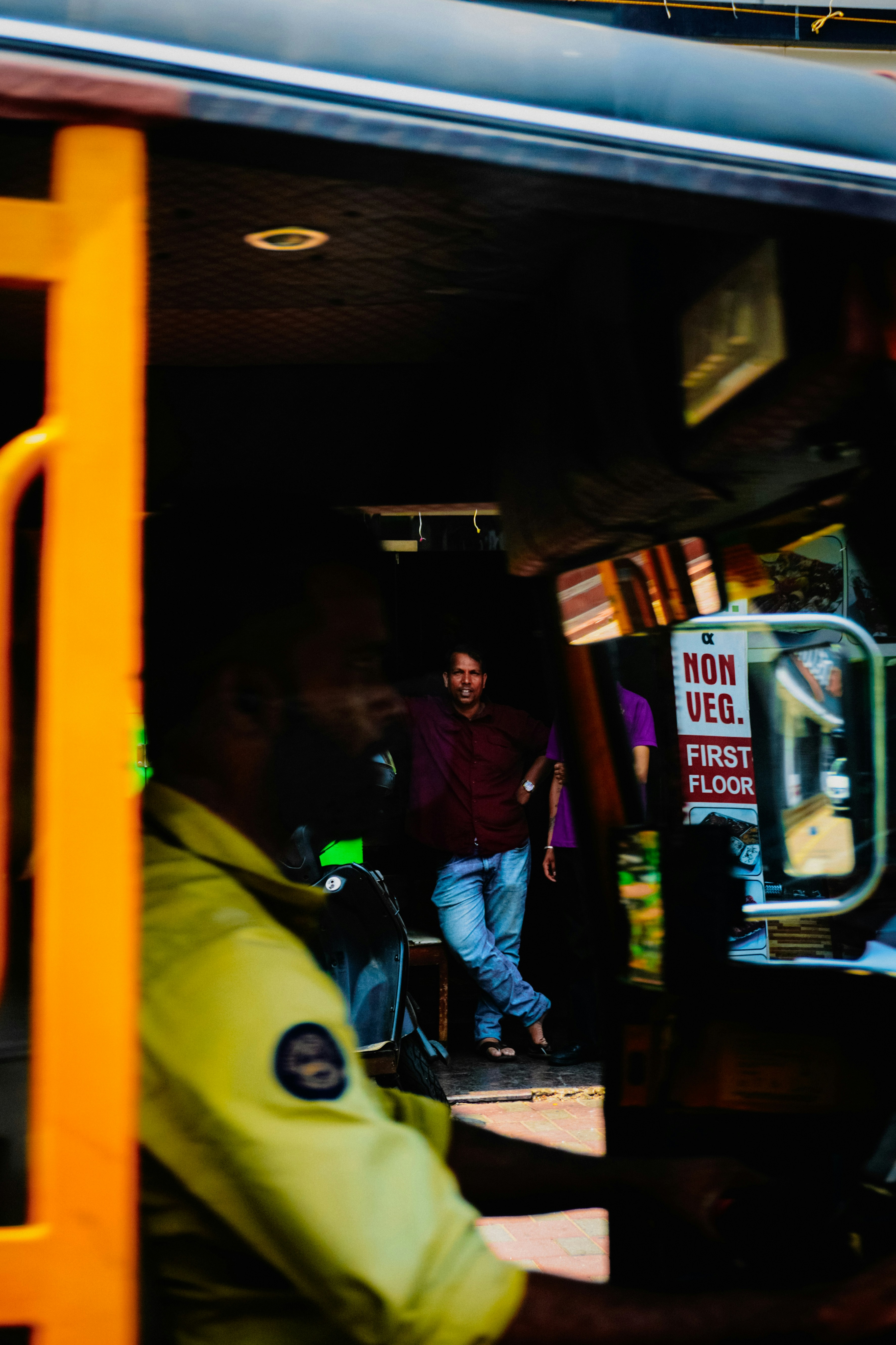 Threshold of the Night Market: A Passenger's Pause Inside a Moving Vehicle