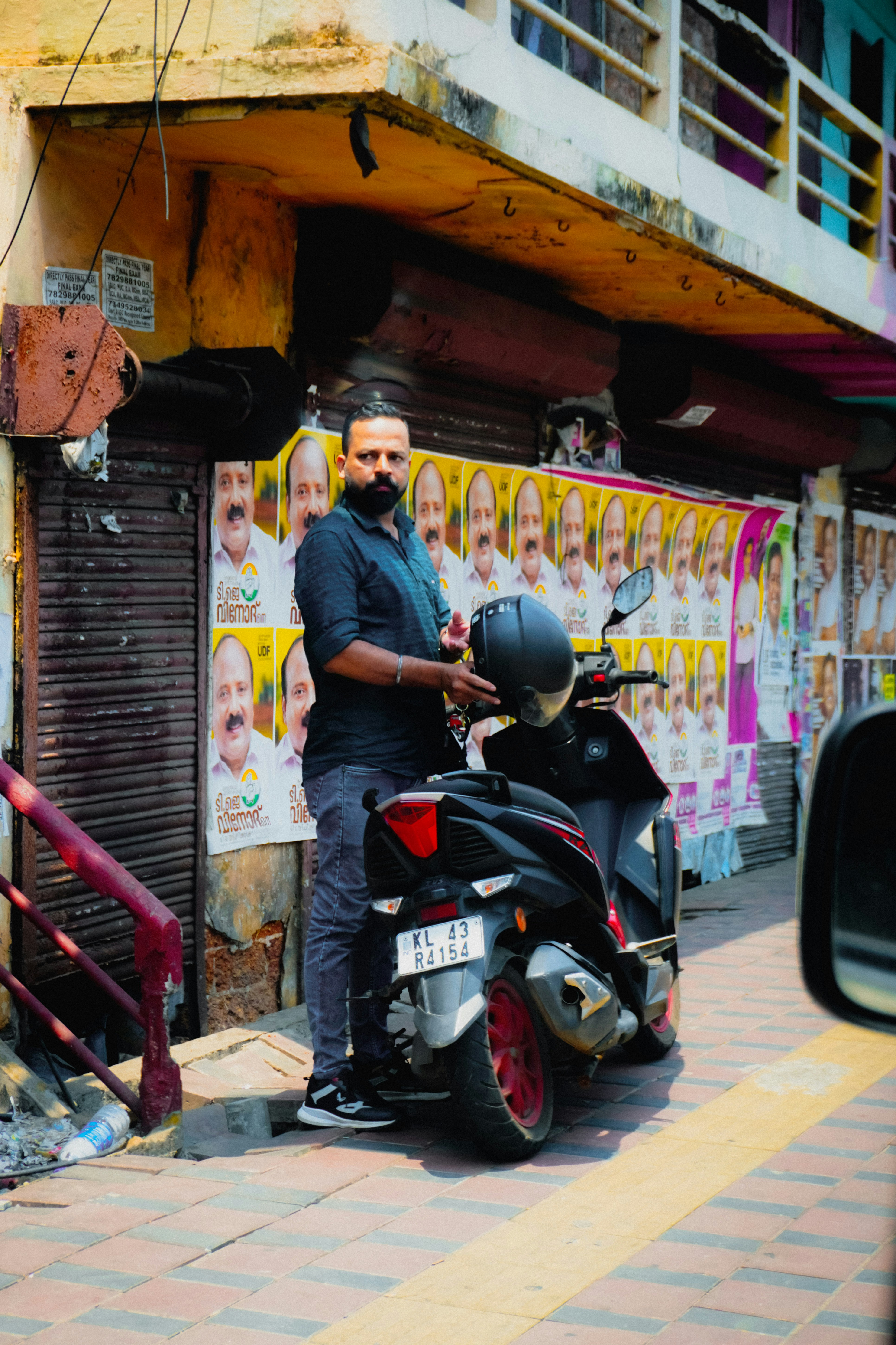 Motorcycle Stop: A Face Behind the Shield in a Colorful Street Corridor