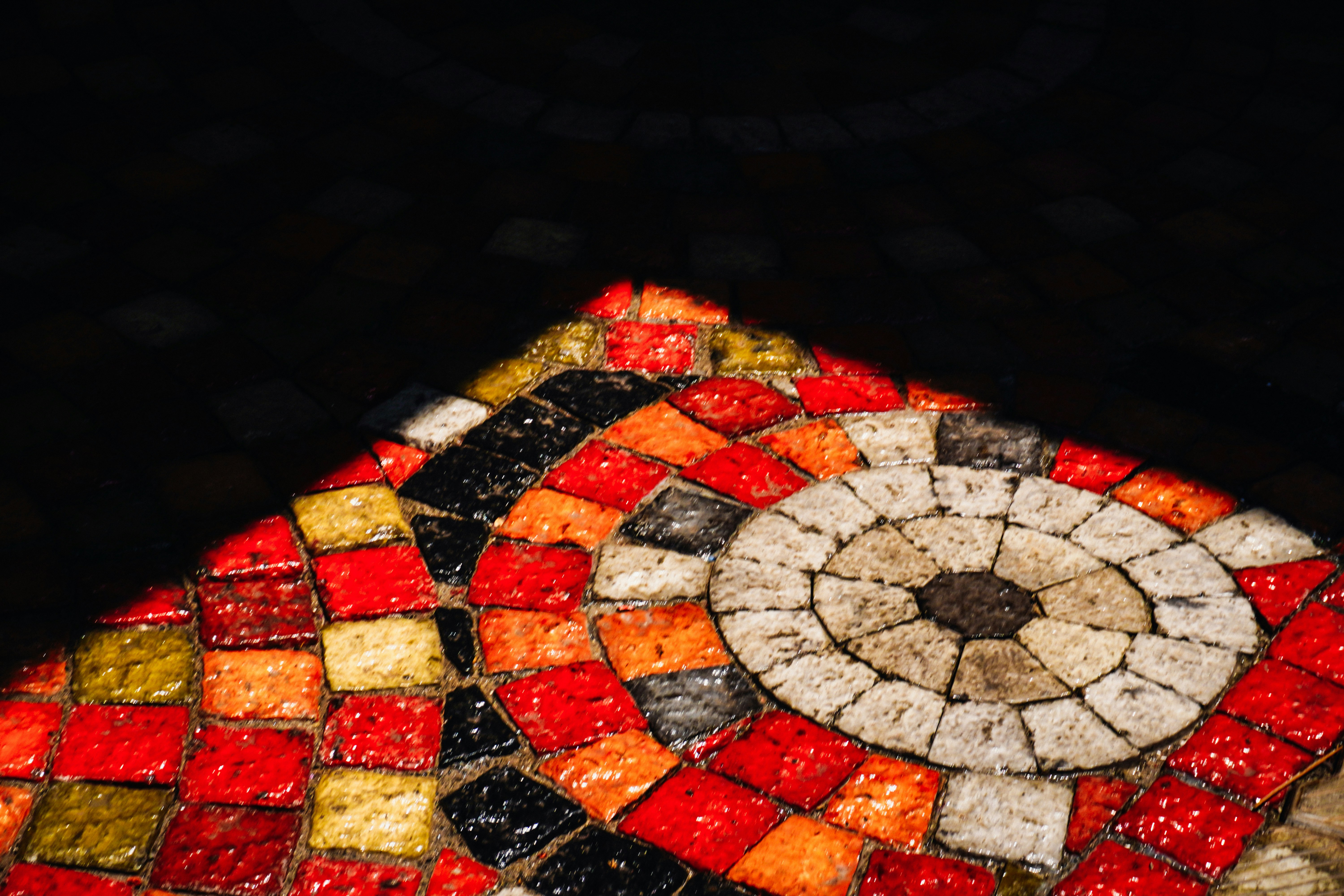 Spiraling Mosaic Spotlight on a Circular Tile