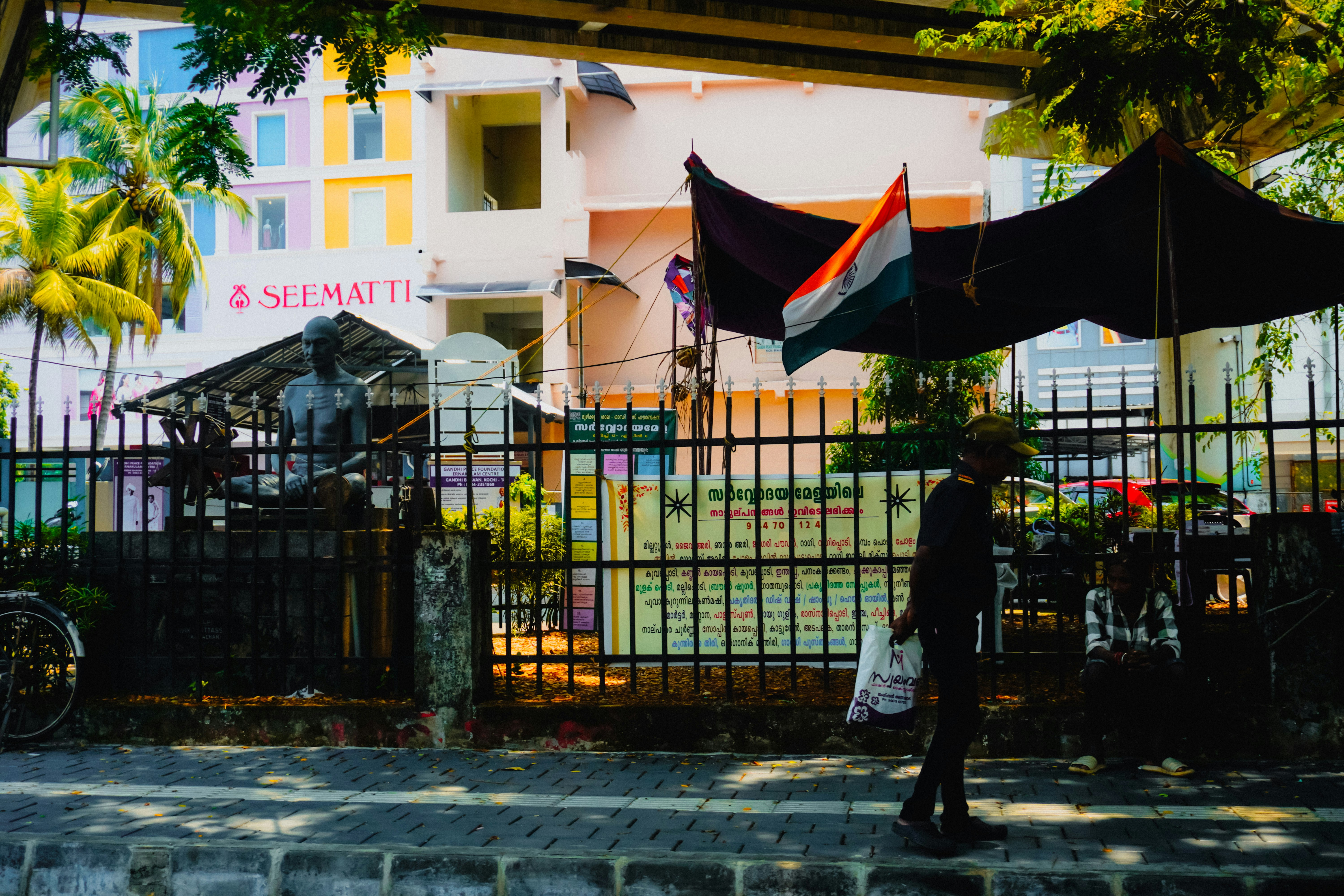 Colorful storefronts and shadowed street: a moment under an urban canopy