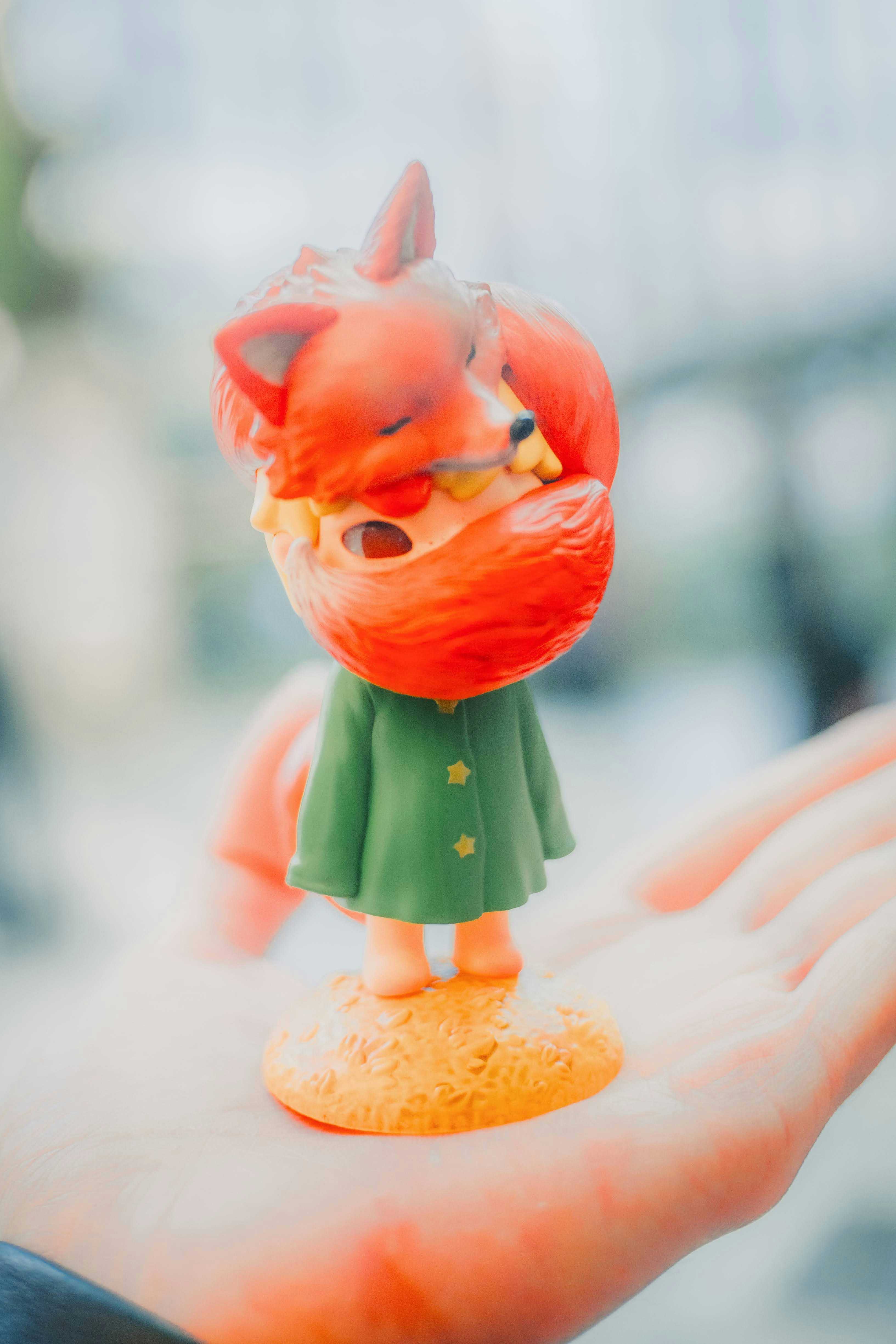 Tiny Sentry: Red Fox Teapot Figure Perched on a Hand