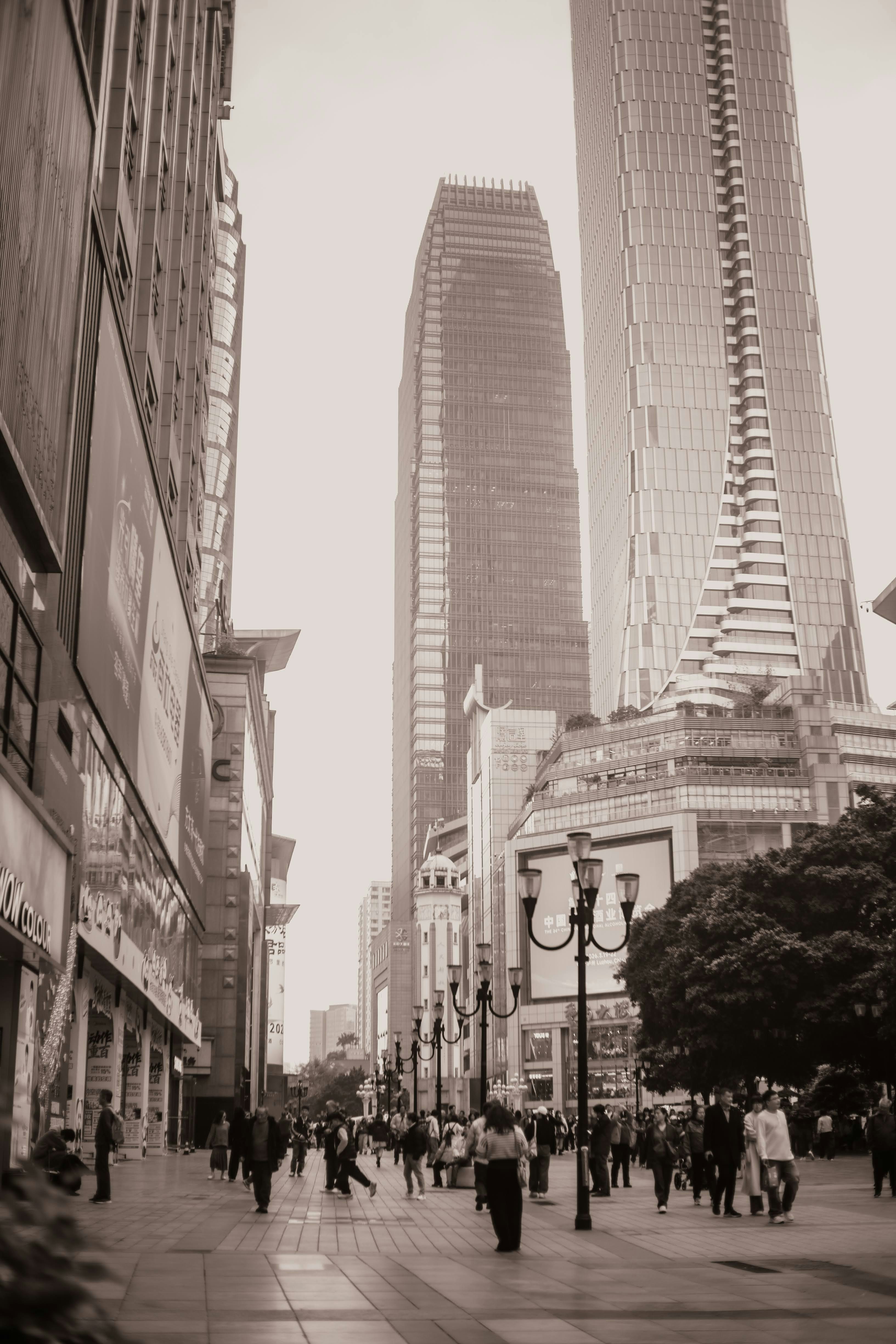 Urban Canyon: Pedestrians and Skyscrapers Converge Along a Sunlit Boulevard