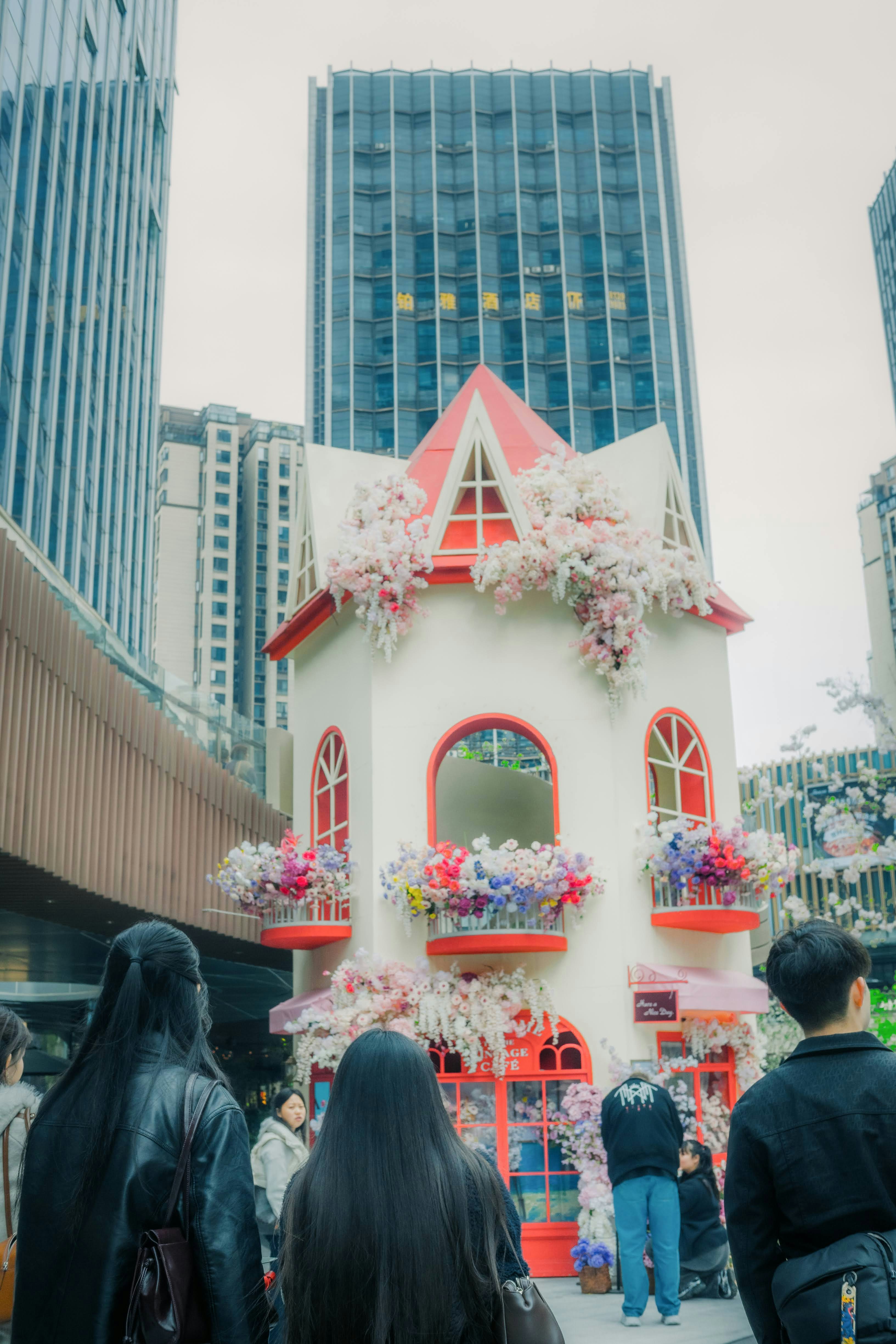 Cherry-Flowered Fairy House Amid City Skyscrapers