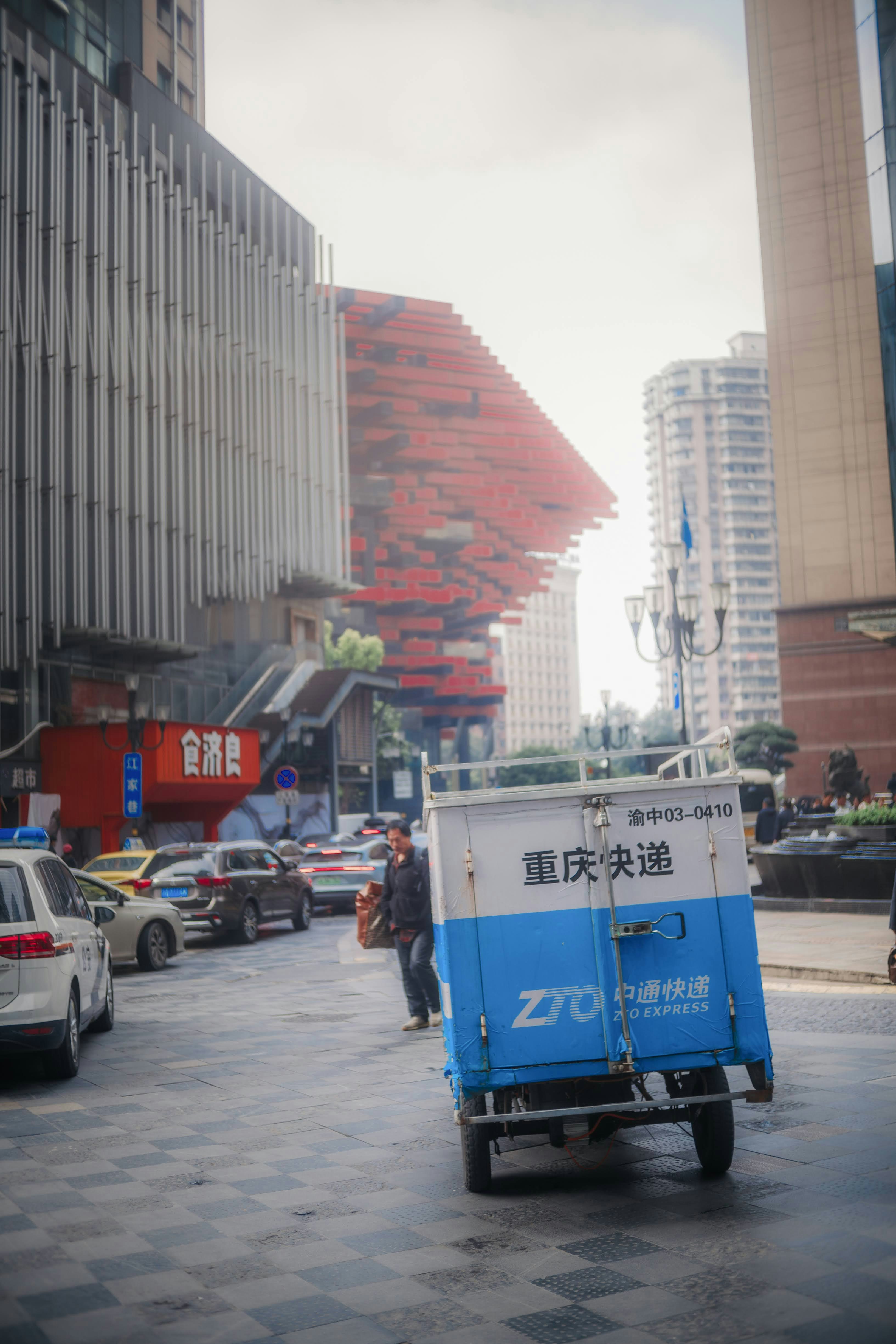 Blue Delivery Cart in a Bustling Urban Canyon