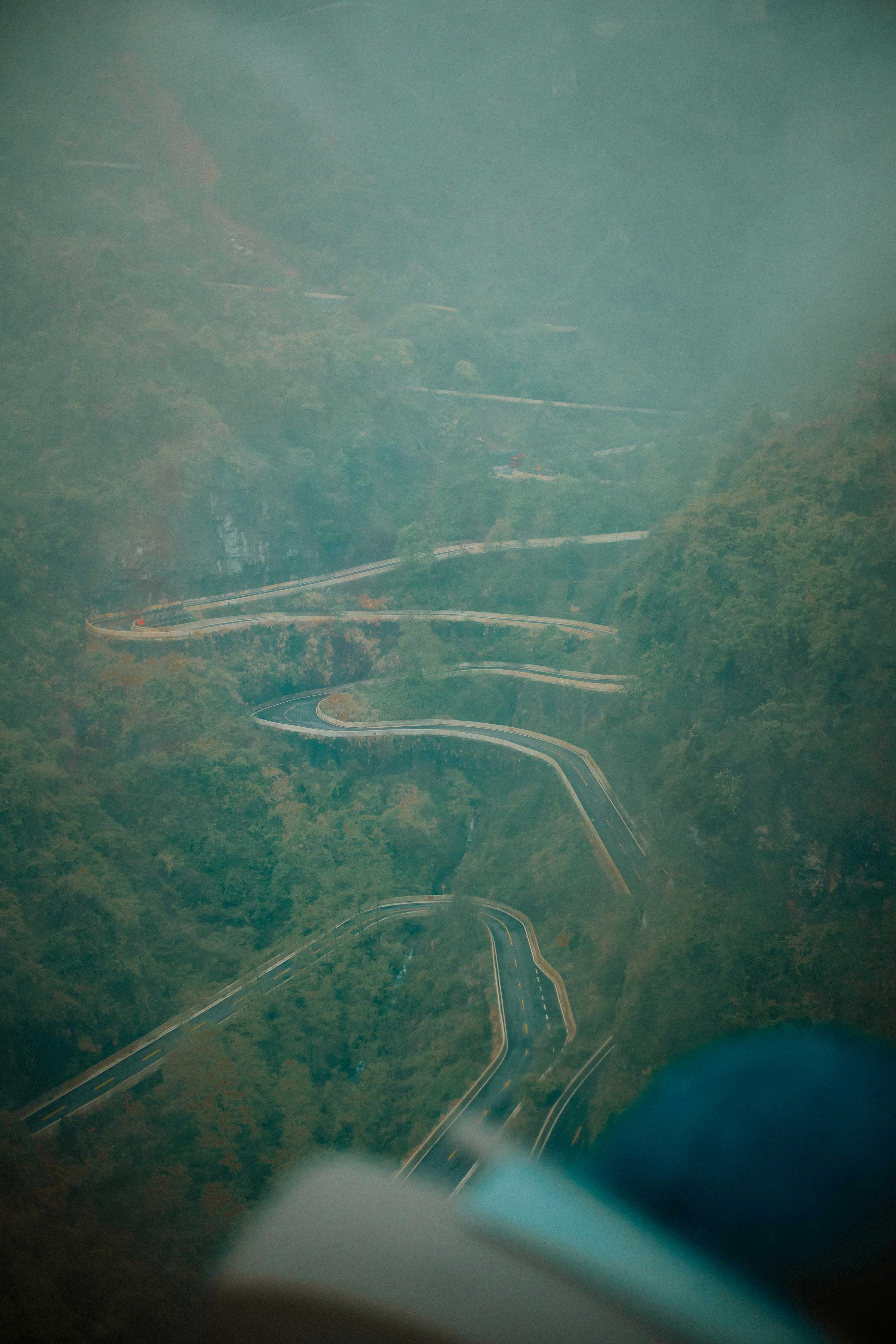 Serpentine Lanes: A Mountain Road Meandered Through Mist
