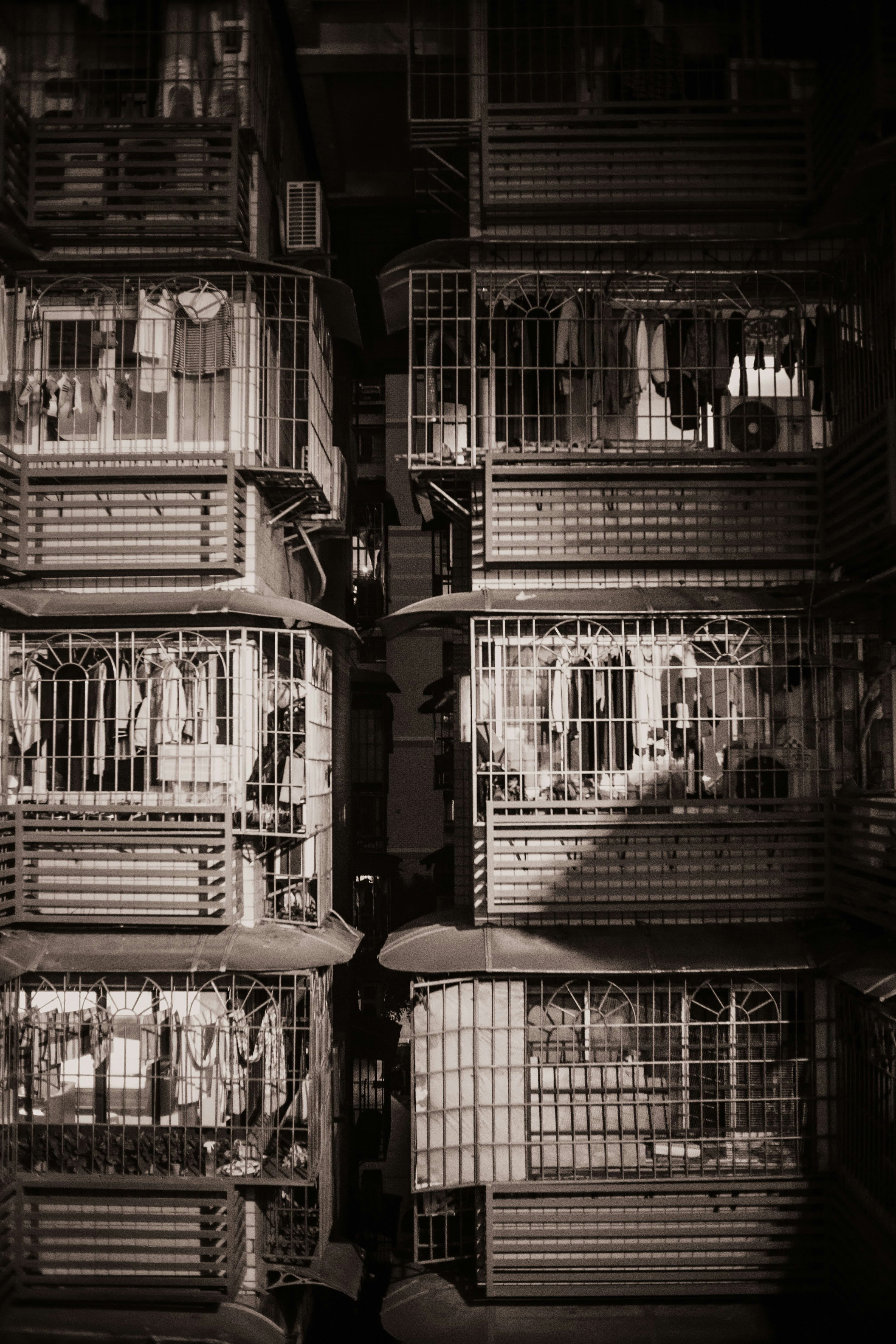 Vertical labyrinth: a courtyard of cages in quiet sepia haze