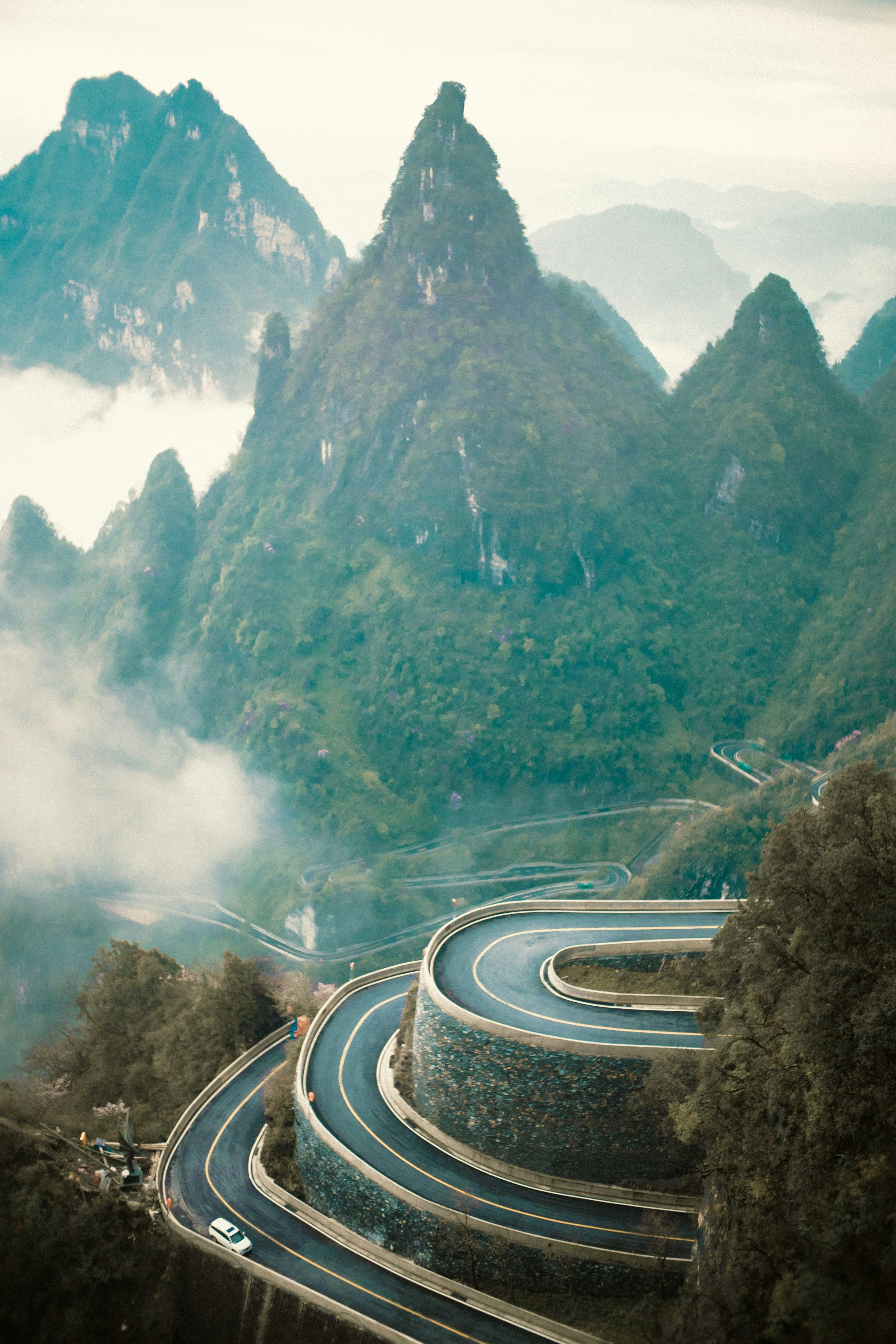 Winding Banister to the Clouds: A Spiraling Road Through Karst Peaks