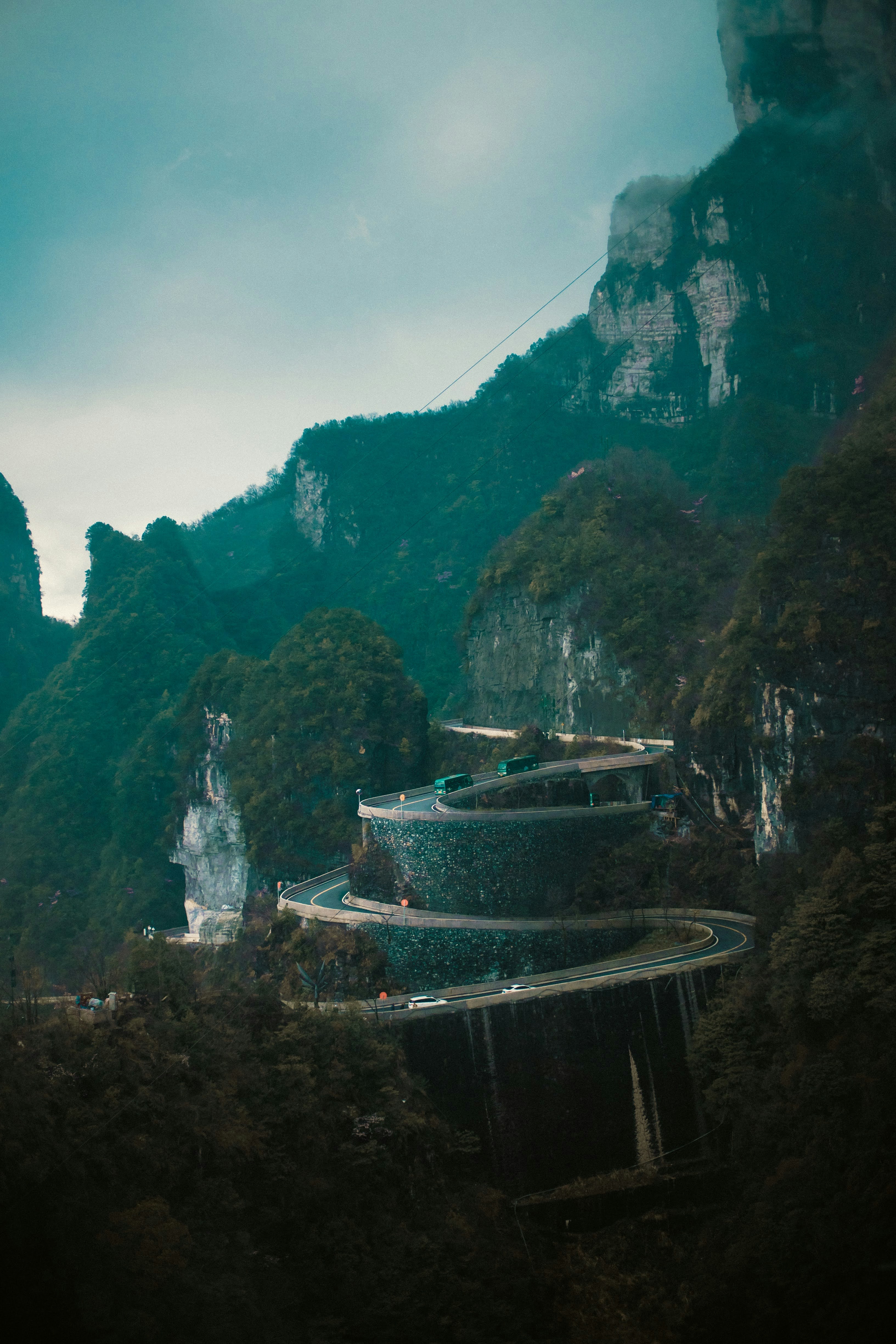 Whispering Switchbacks: Carving Through Misty Cliffs