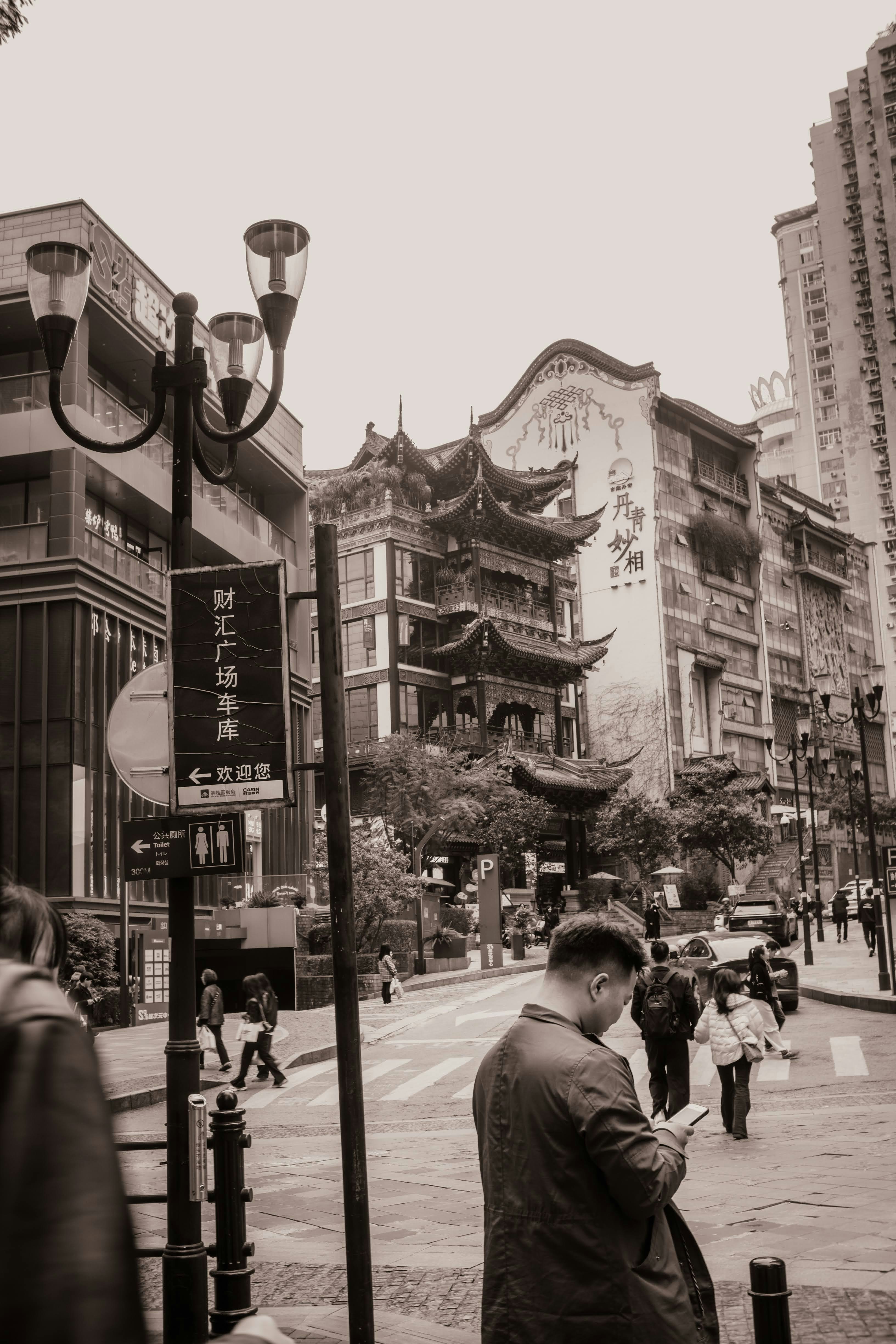 City Gate and Lanterns: People Walk the Historic Street
