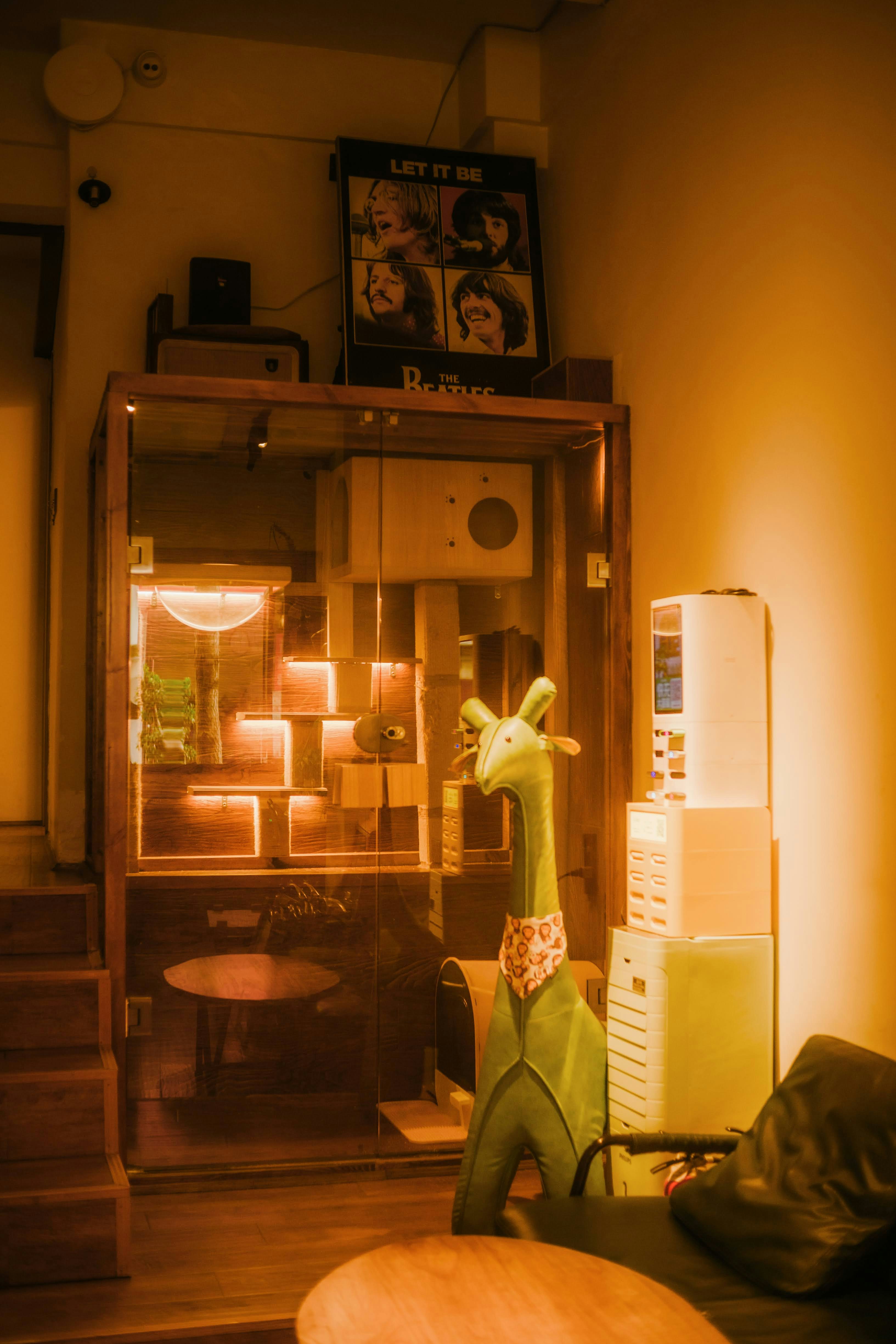 Indoor gallery vibe with a whimsical green giraffe sculpture