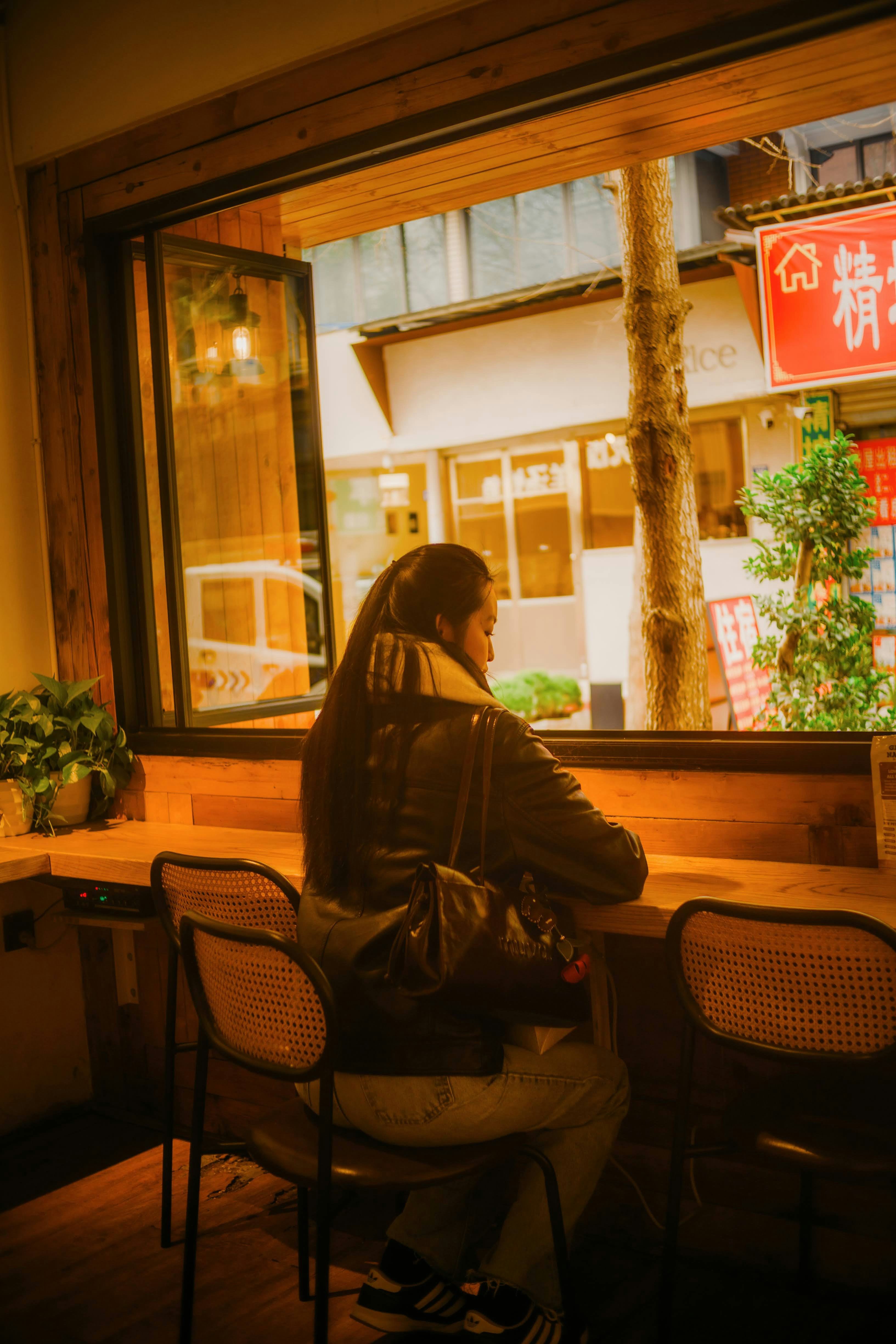 Sitting in Warm Glow: a Quiet Moment at the Cafe Window