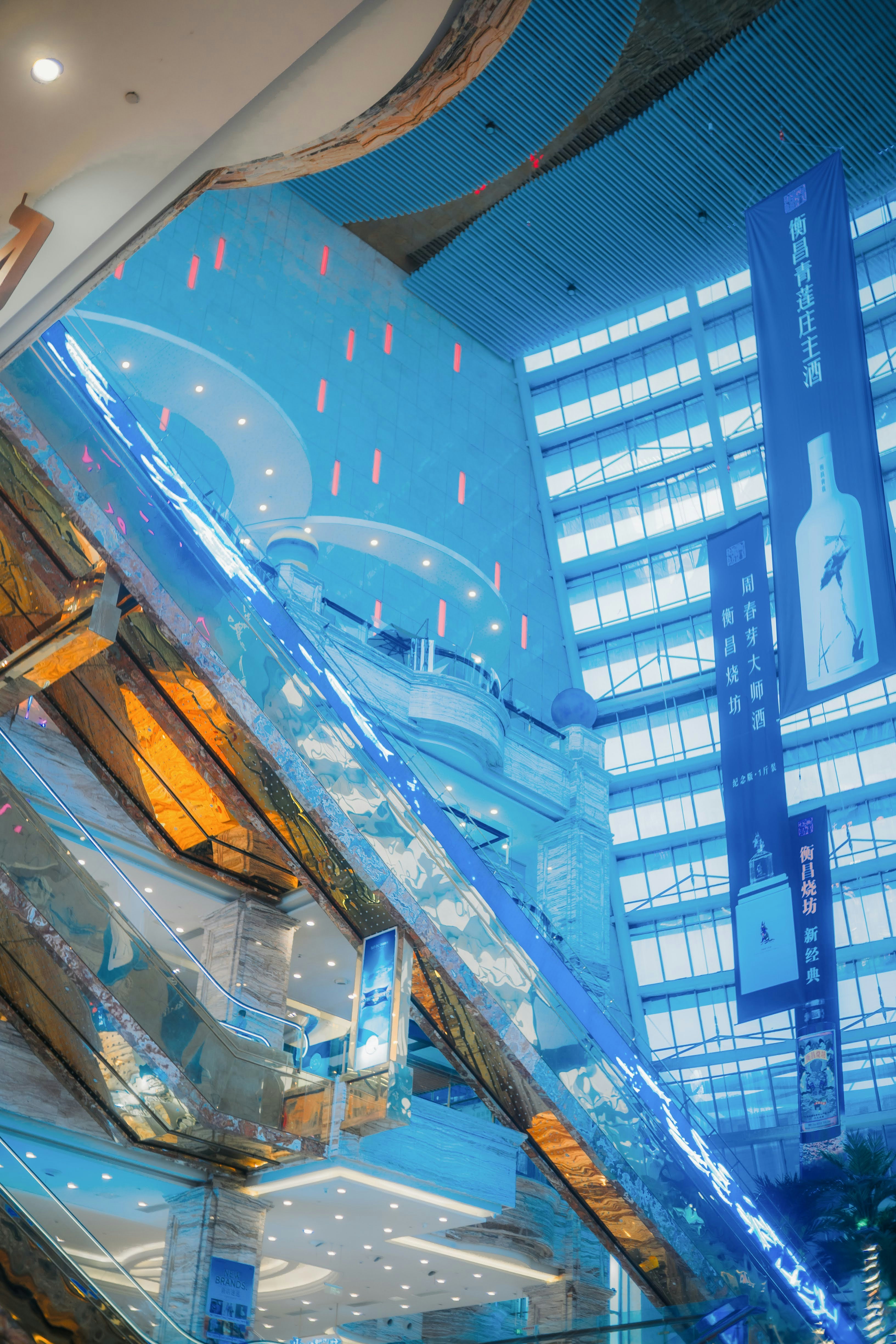 Blue Atrium Ascend: Neon Rails and Glass Escalators