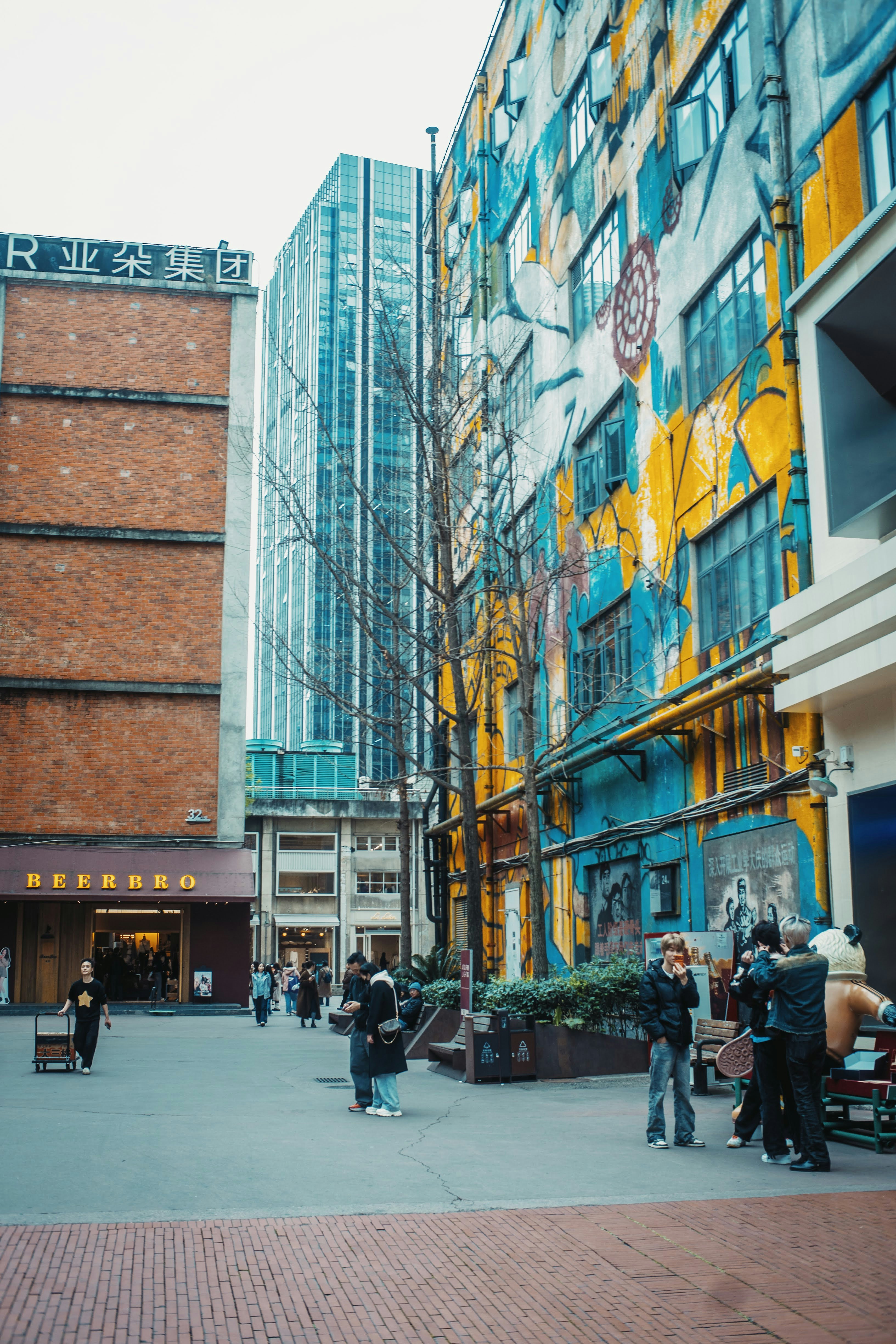 Muraled Courtyard: Colorful Urban Facades and People in Motion