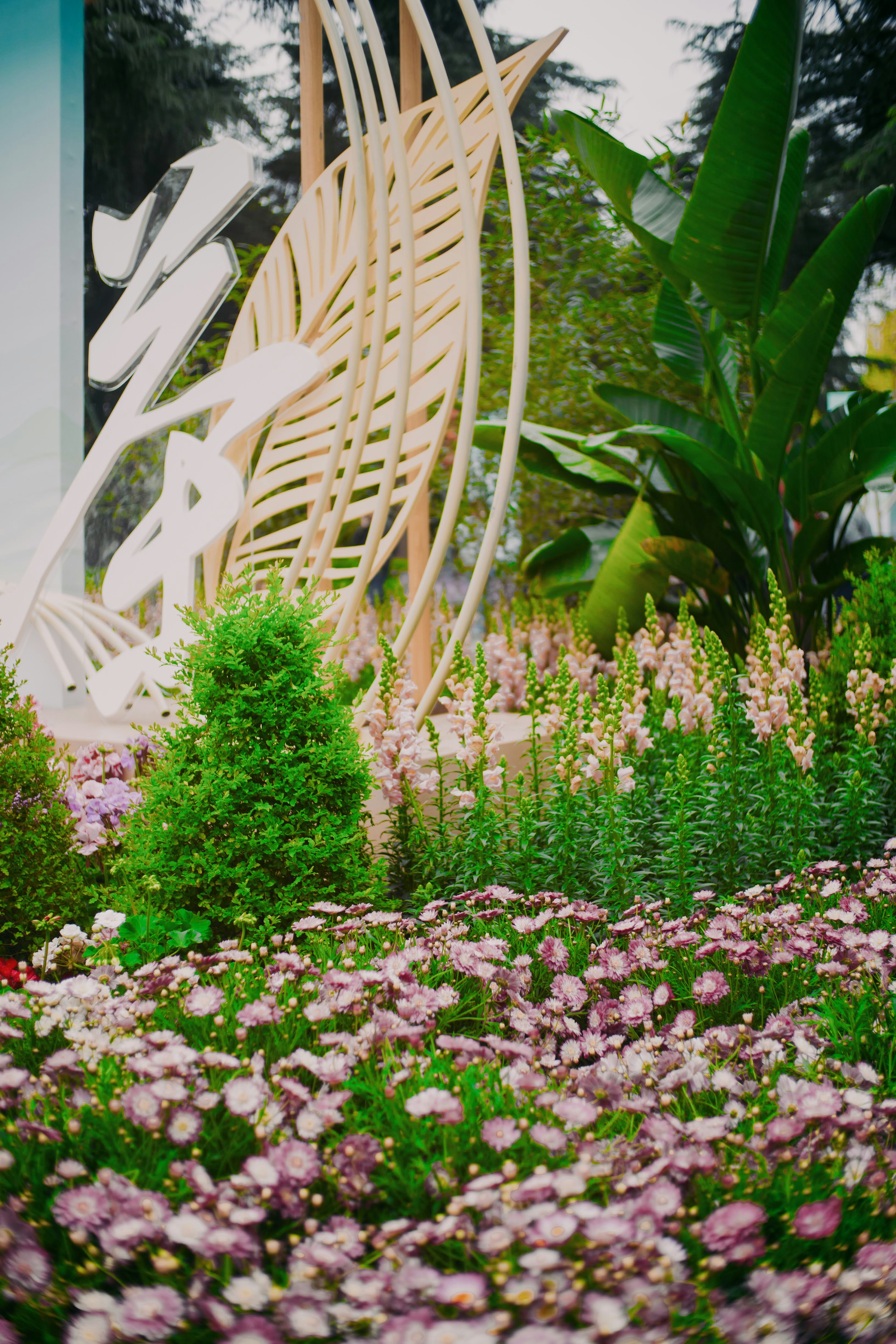 Garden Sculpture in Bloom: Abstract Forms Meet a Sea of Petals
