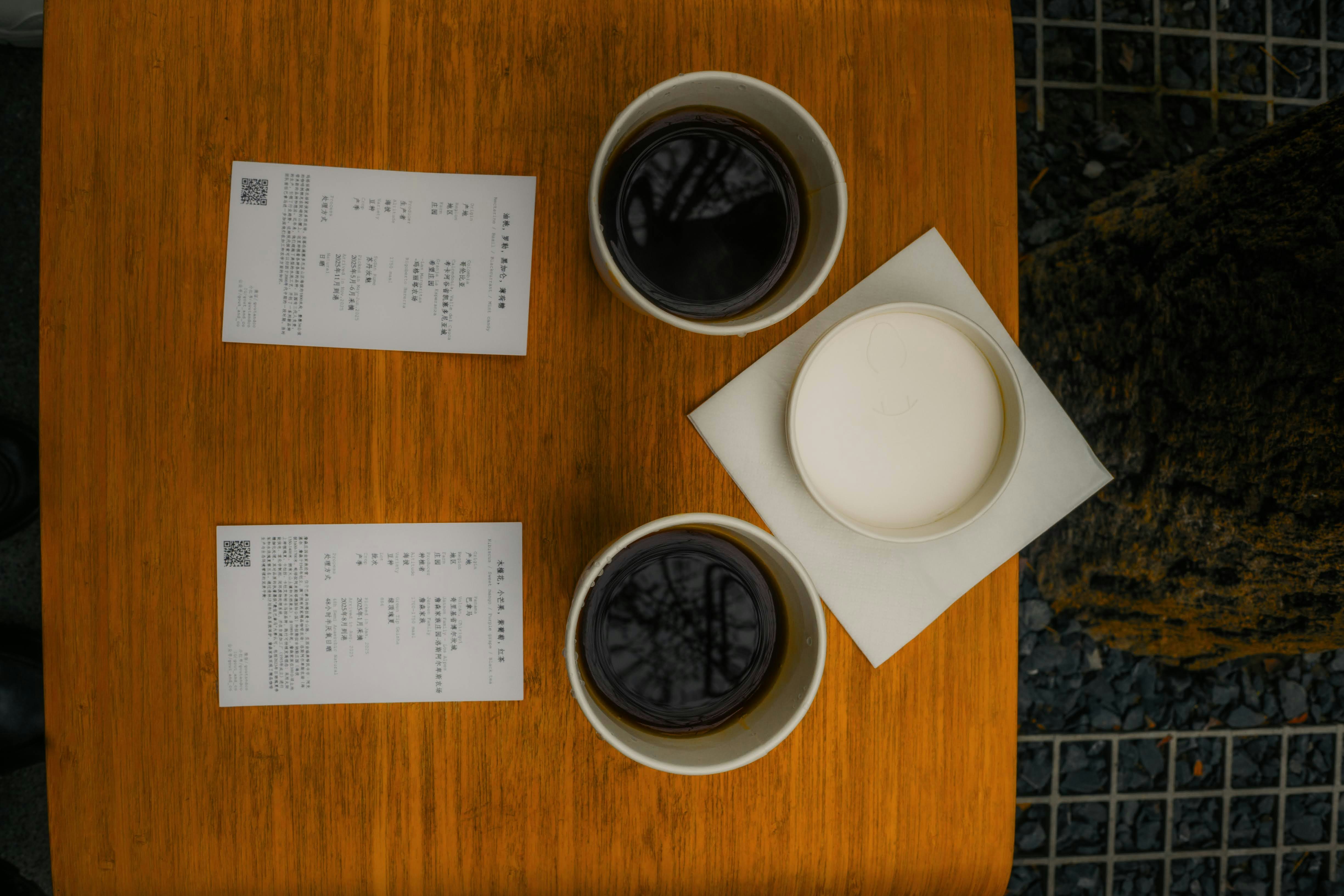 A Quiet Café Tableau: Two Cups and a Candle on a Wooden Table