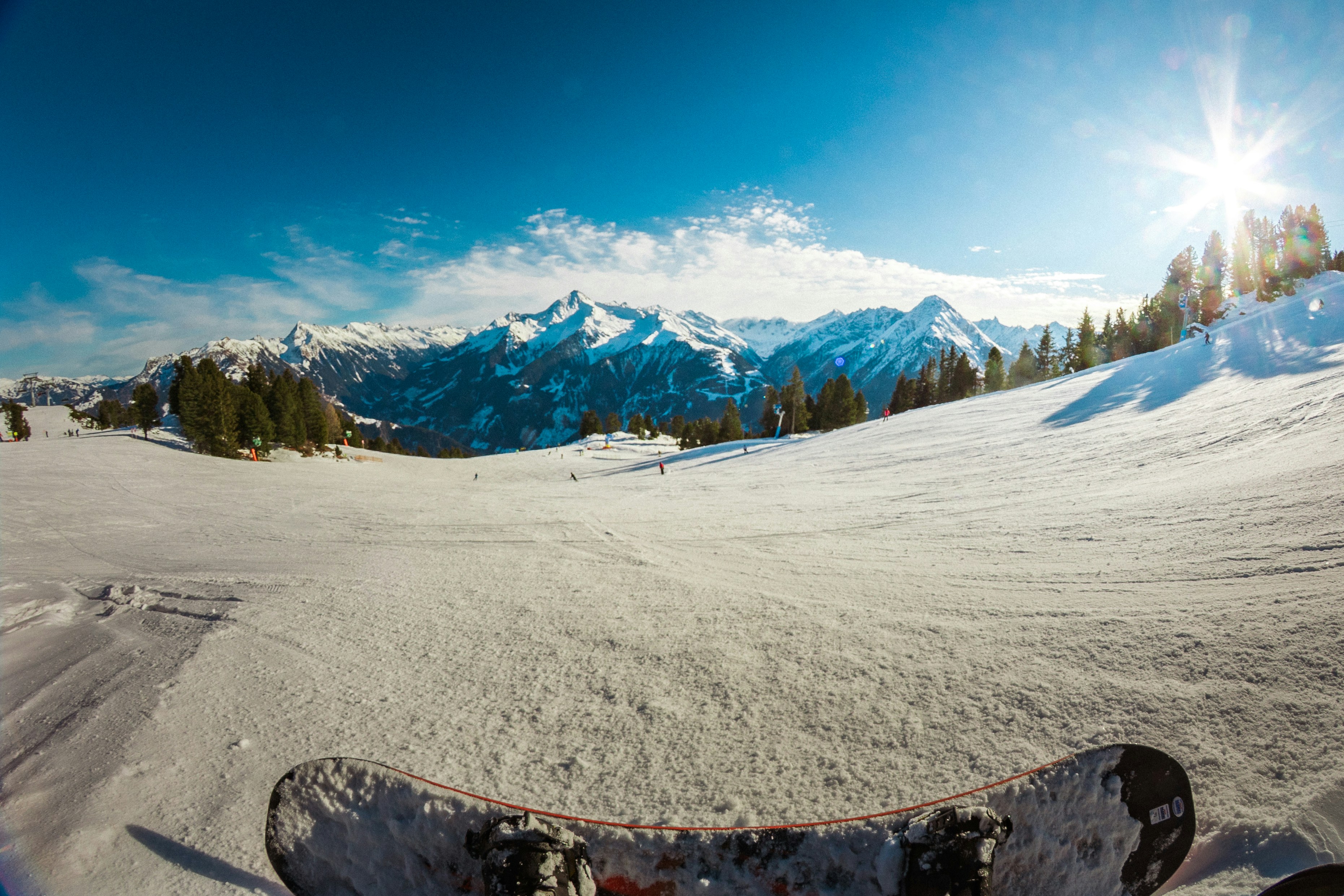 Snowboarder's Perspective: Horizon of Peaks Under a Bright Alpine Sun