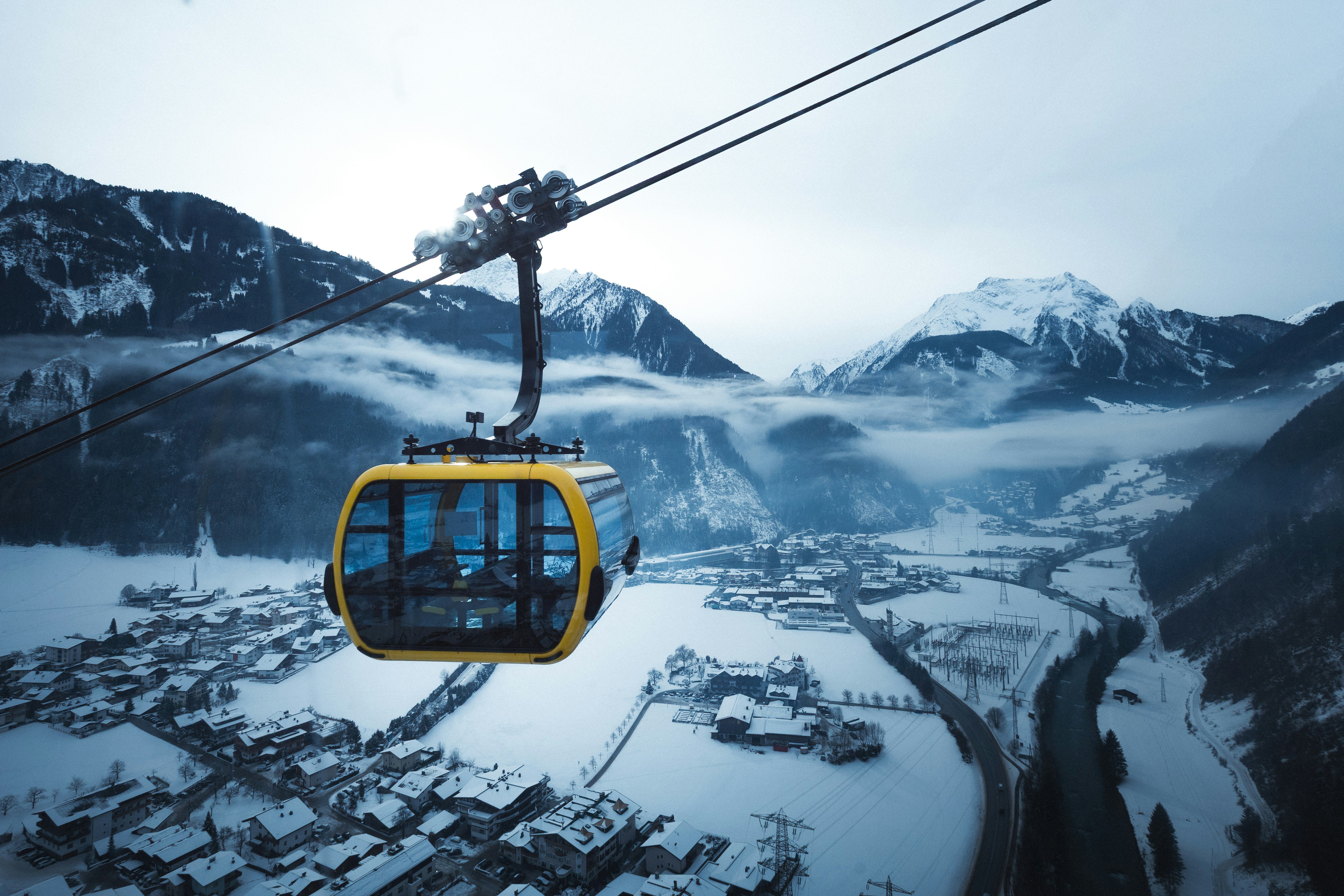 Yellow Cabin in the Snow: Aerial Lift Over a Frozen Valley