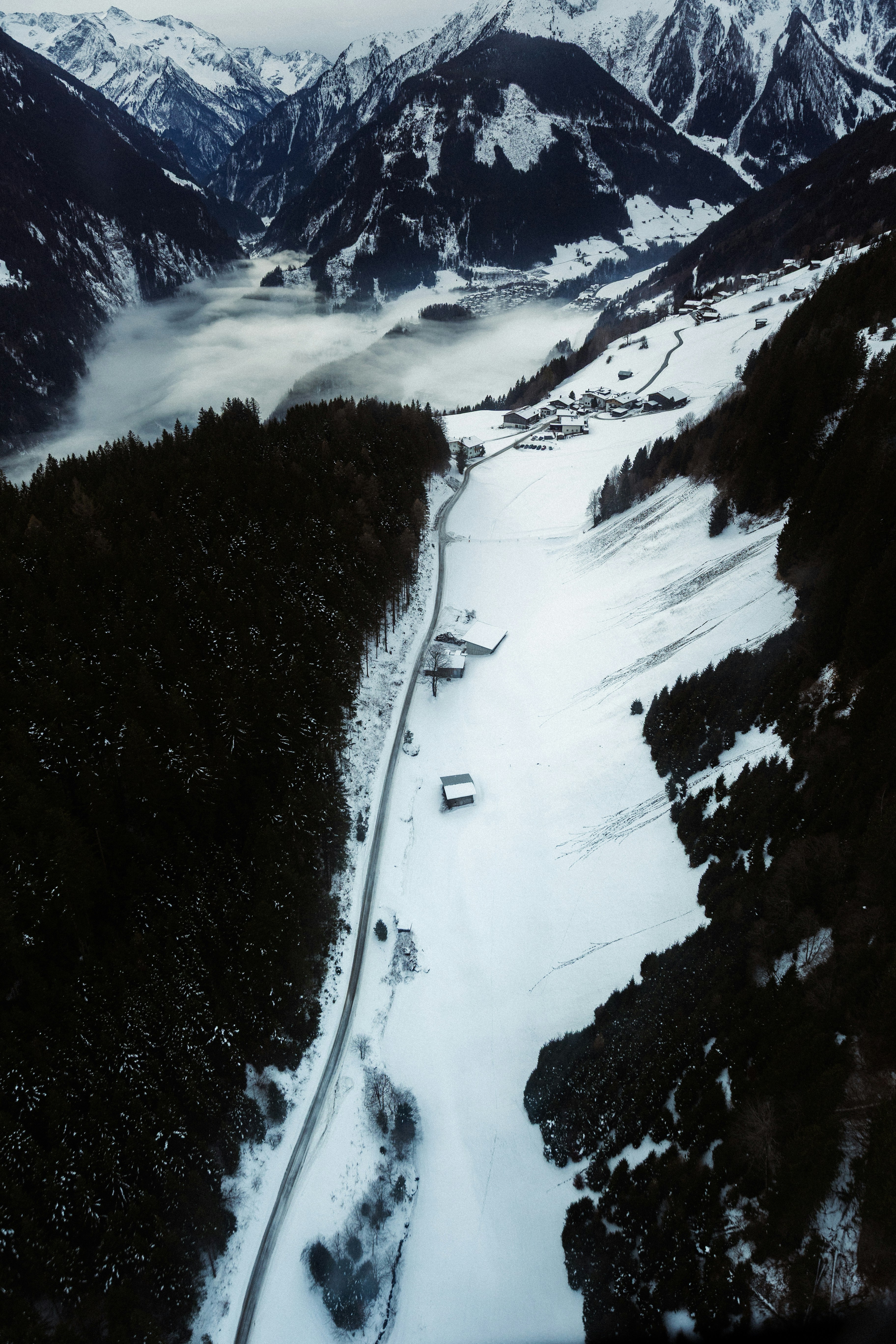 Snowbound Valley Ascent: A Nestled Alpine Village Amid Narrow Passages