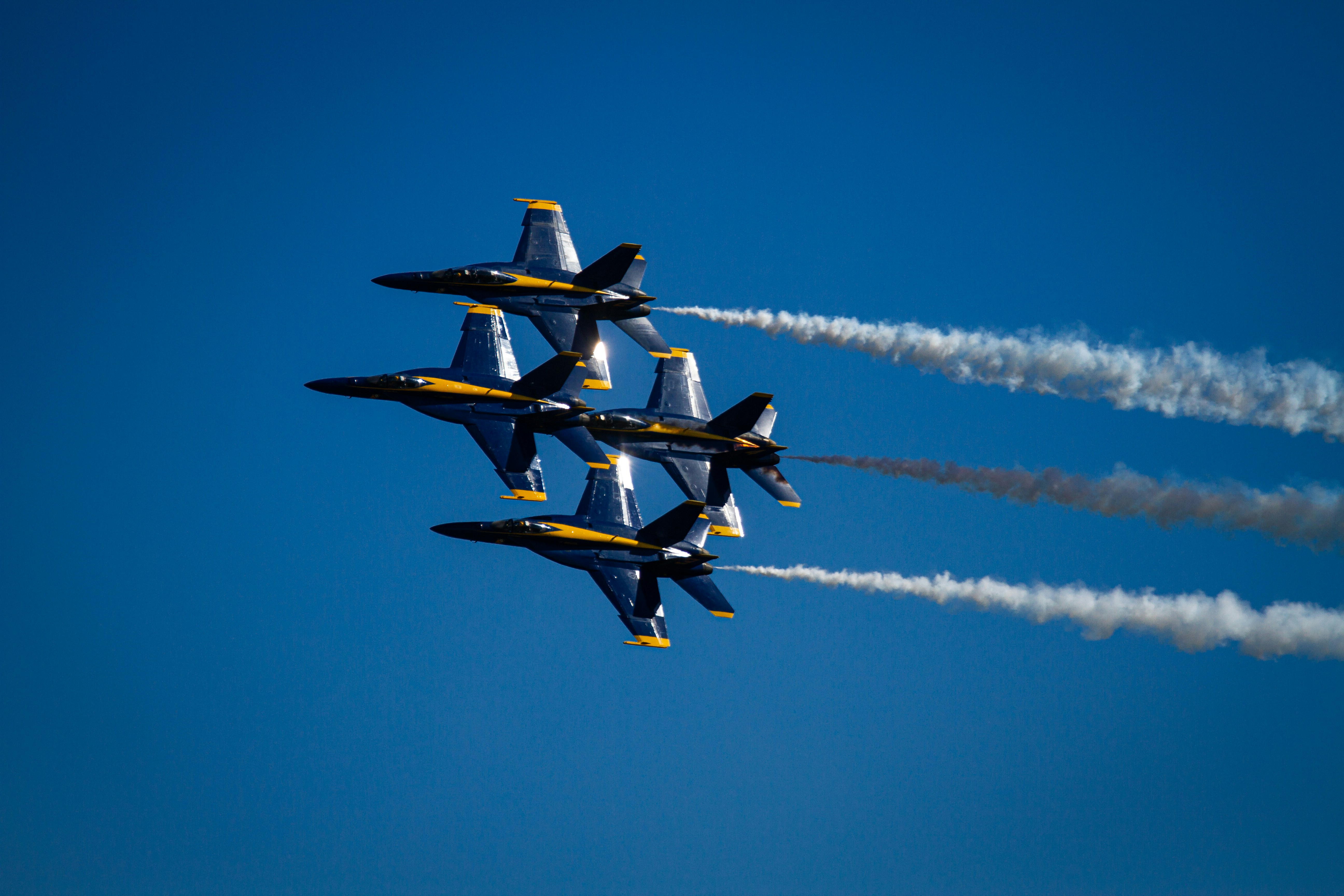 Triad in the Sky: A Tight Formation of Blue and Gold Contrails
