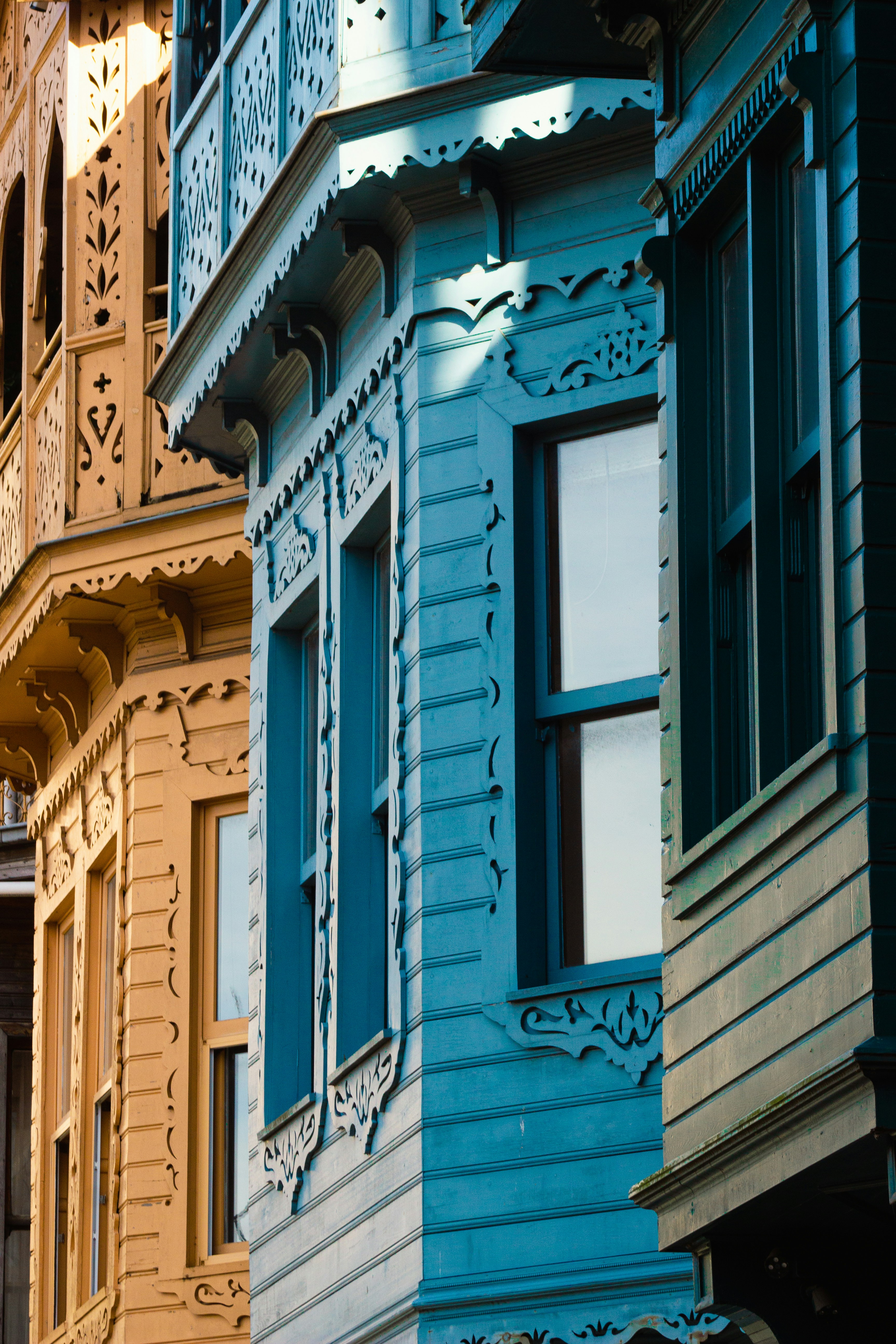 Colorful Victorian Facade: Intricate Woodwork in Blue Townhouse