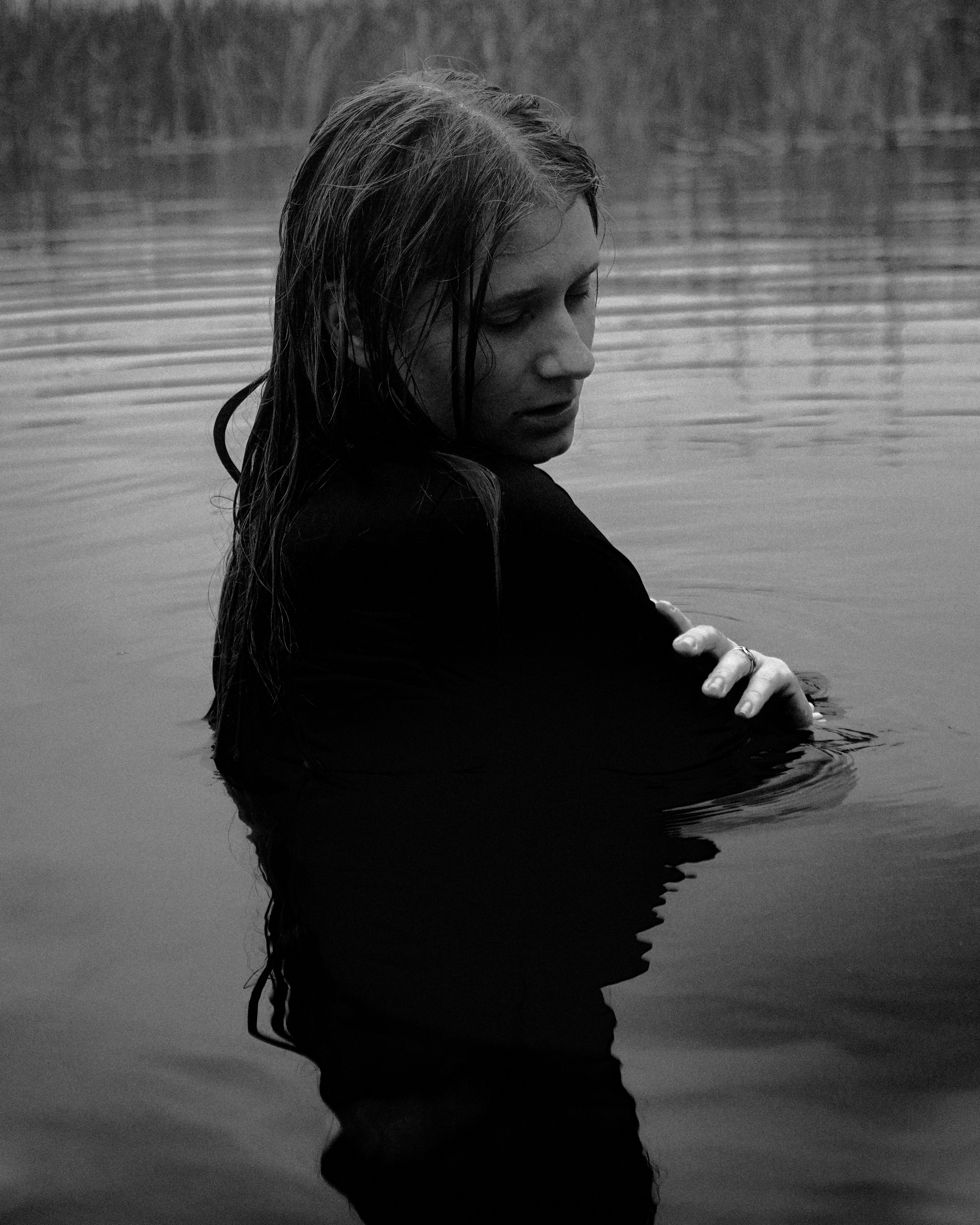Muted Reflections: A Quiet Portrait in Midnight Water