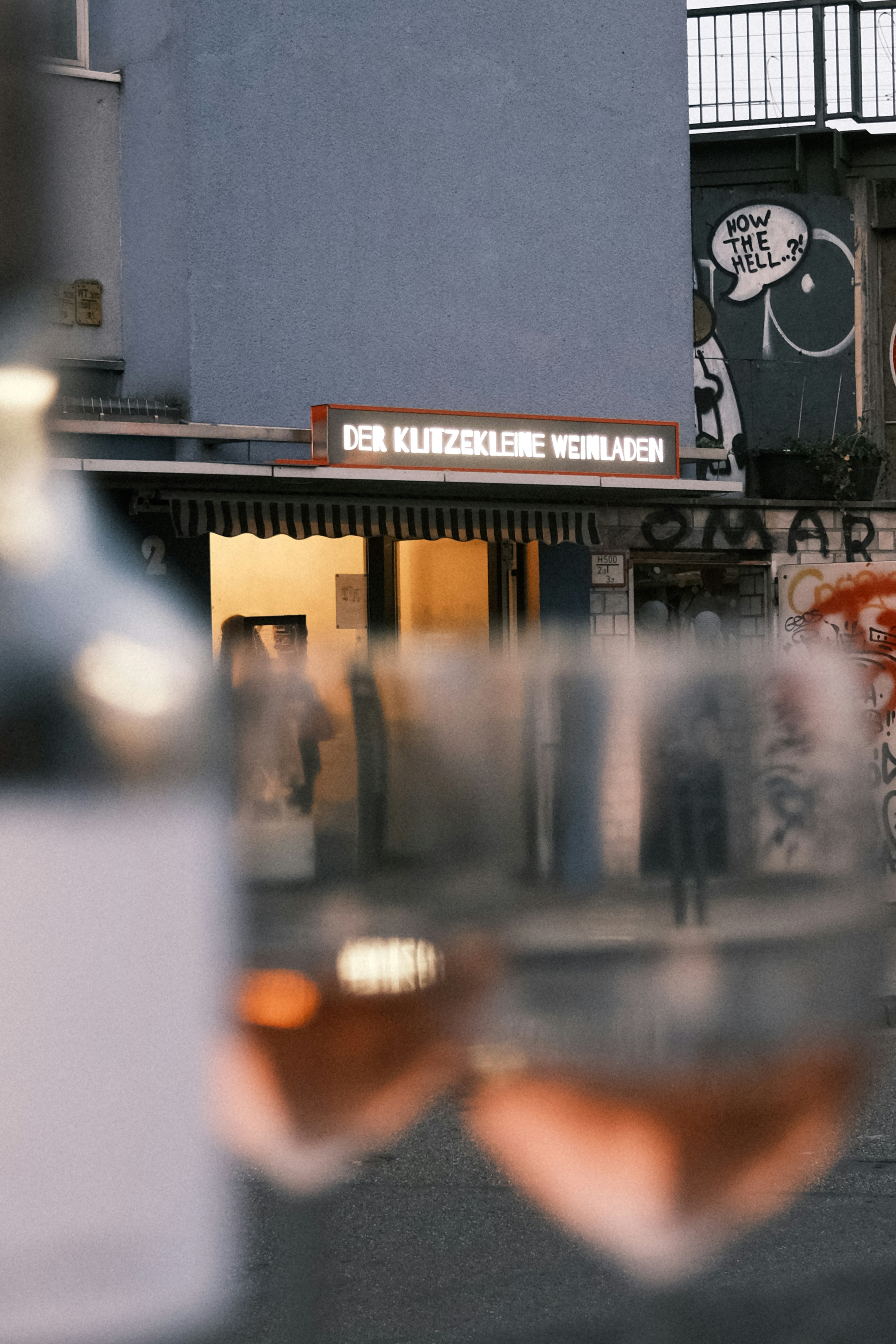Neon Sign, Graffiti Wall, and a Blur of City Life