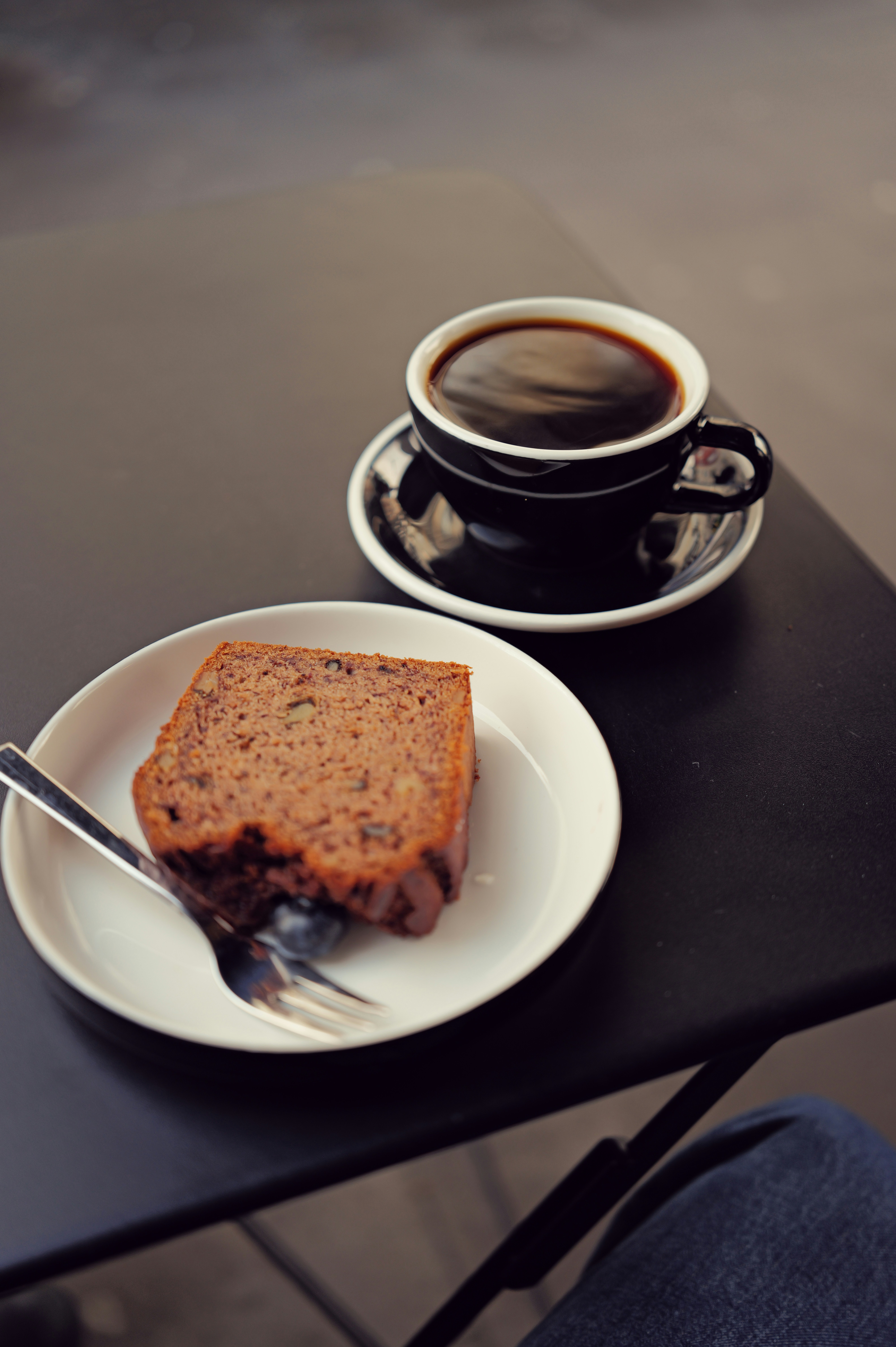 Midday Brunch Moment: A Slice of Coffee and Cake on a Café Table