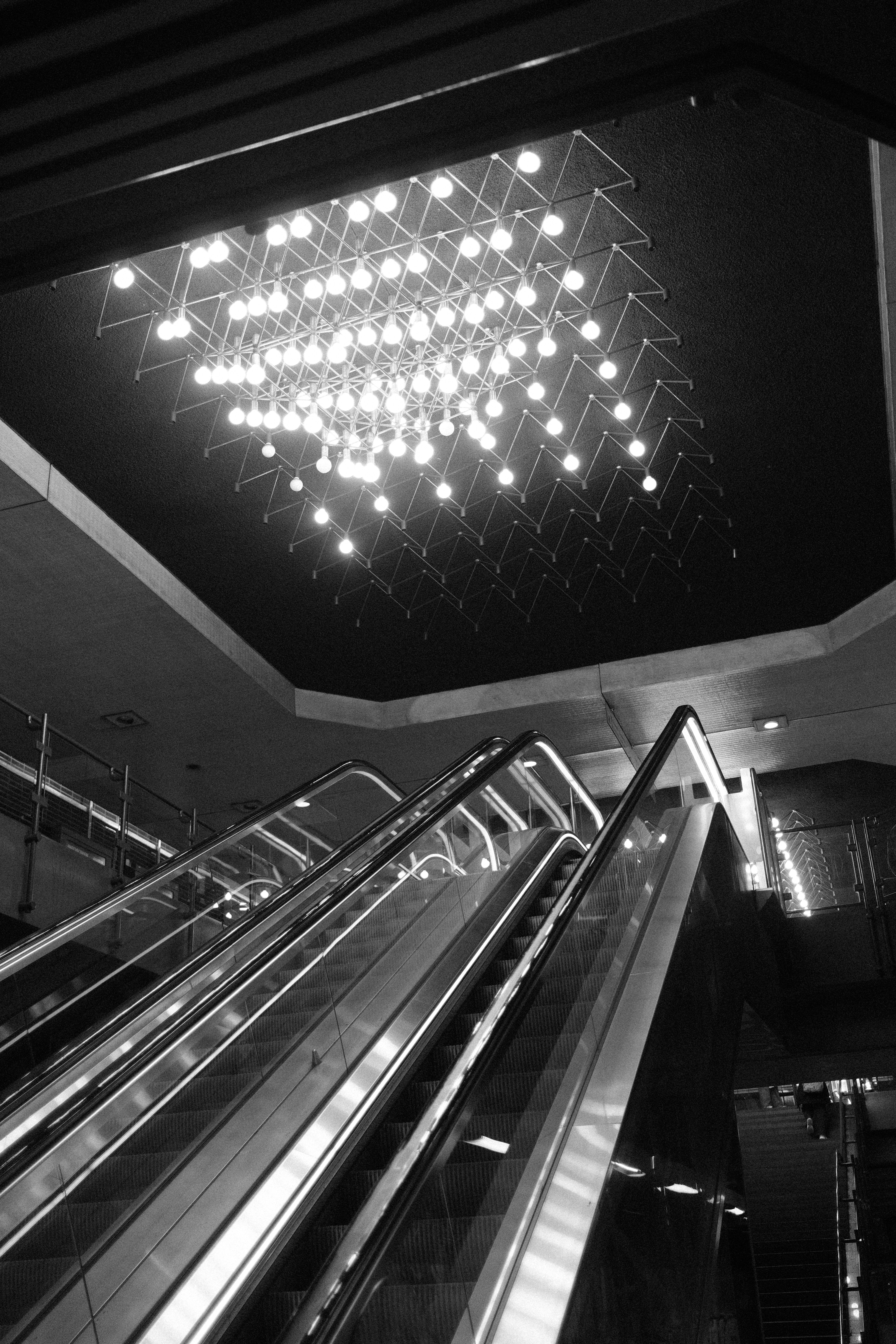 Glowing Grid Above the Escalators