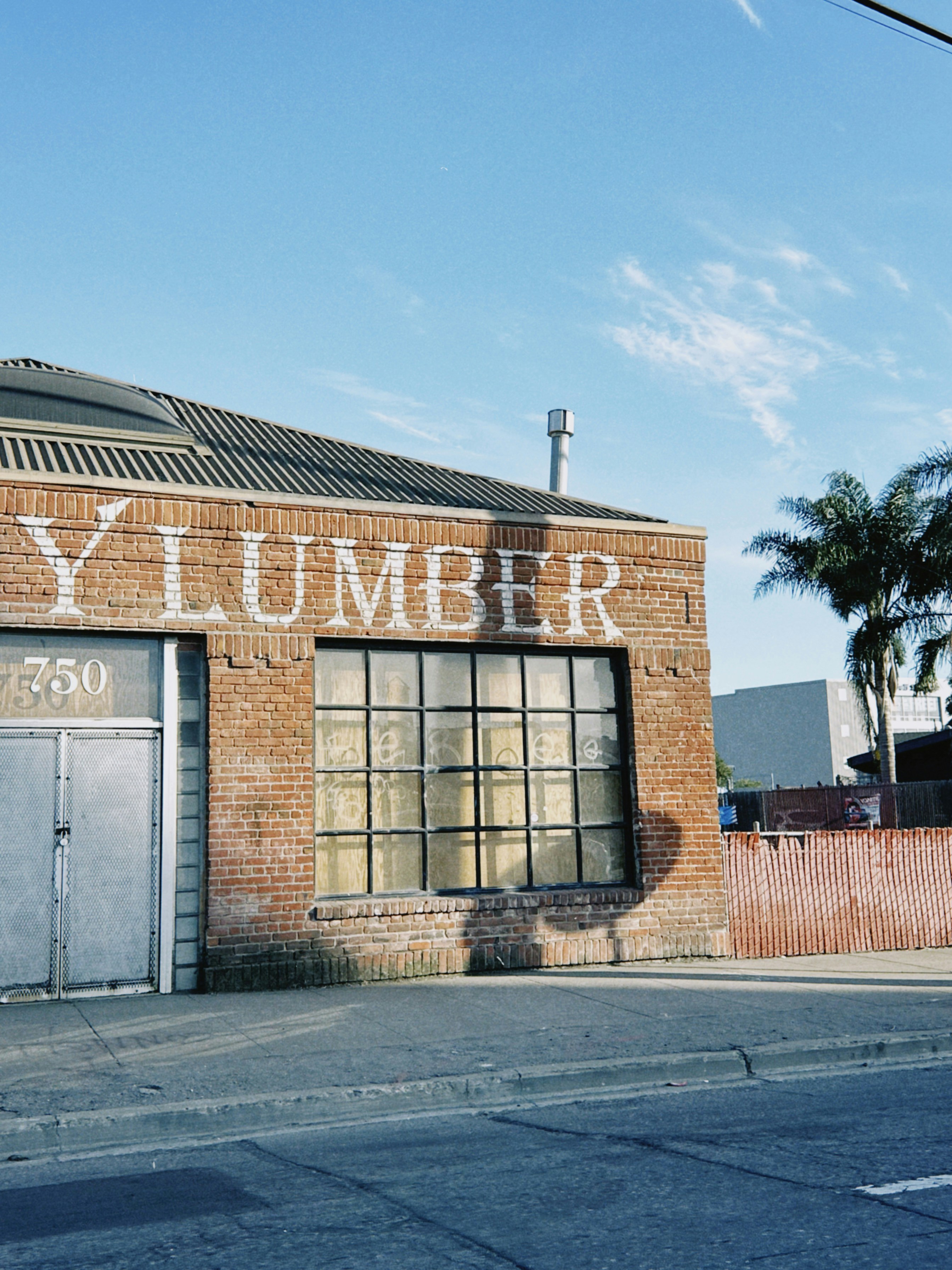 Brick Warehouse with Weathered Sign and Glass Block Window