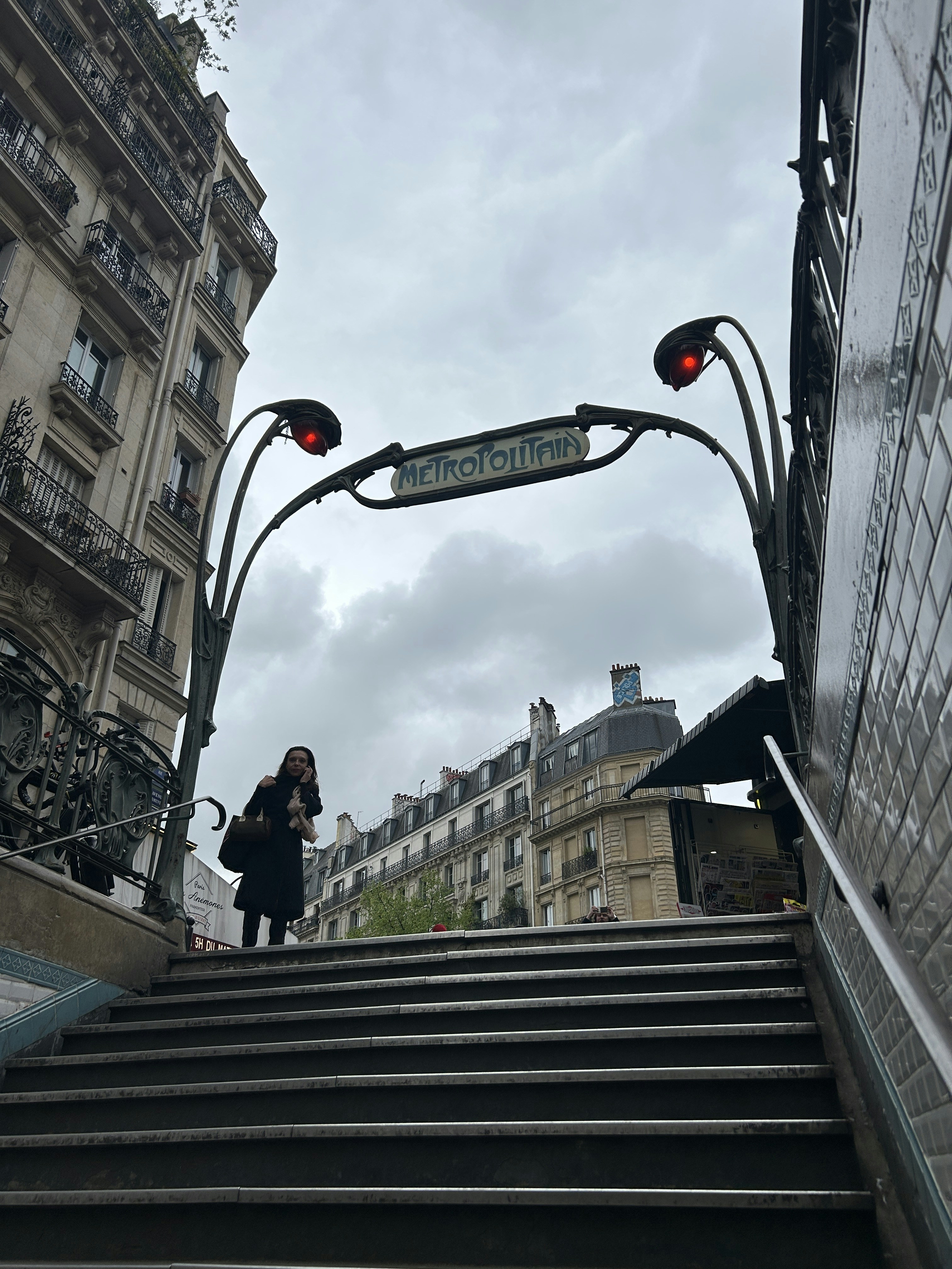 Metro Stairs to the City: A Portrait Under the Parisian Arch