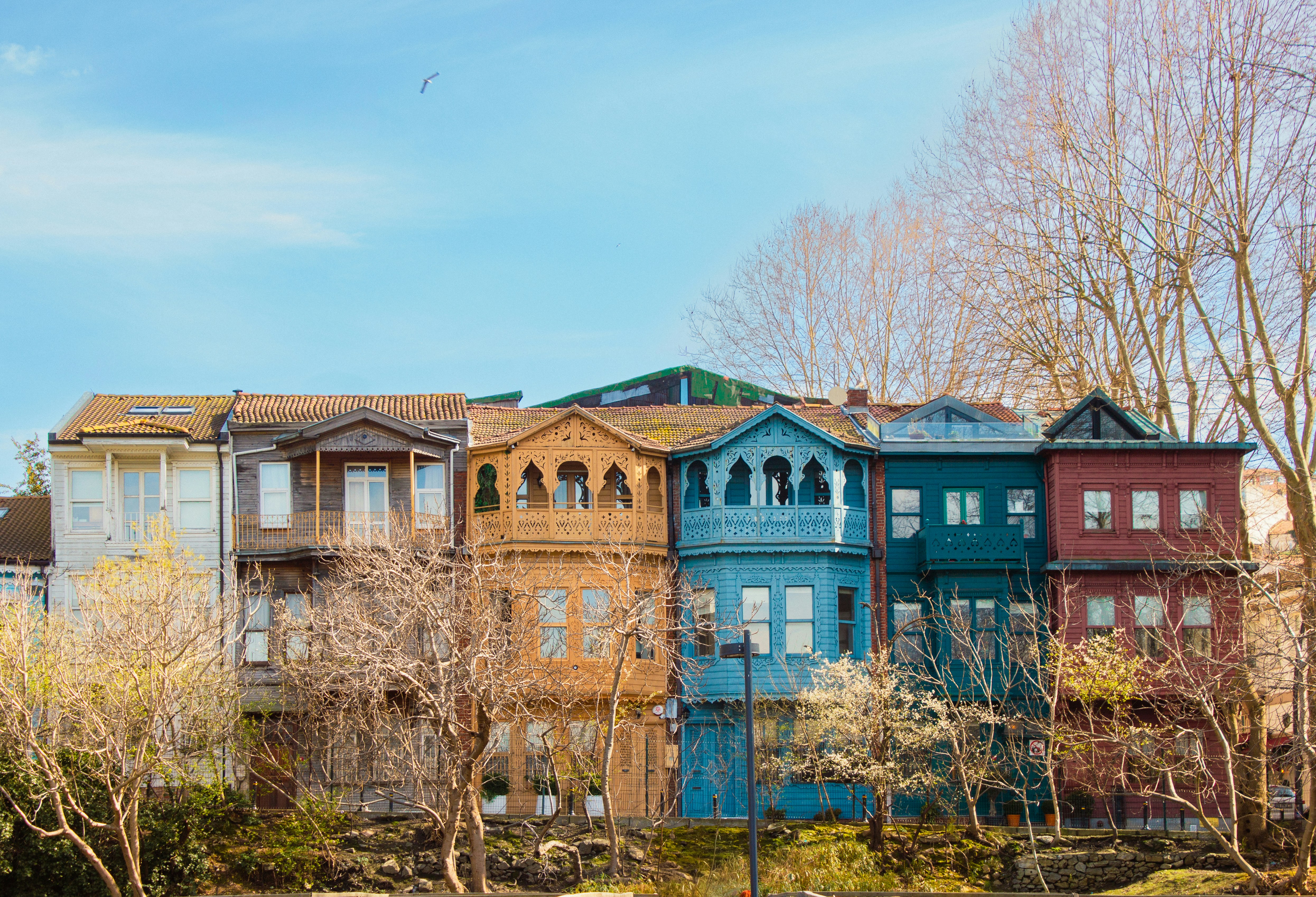 Row of Painted Wood Townhouses Under a Clear Sky
