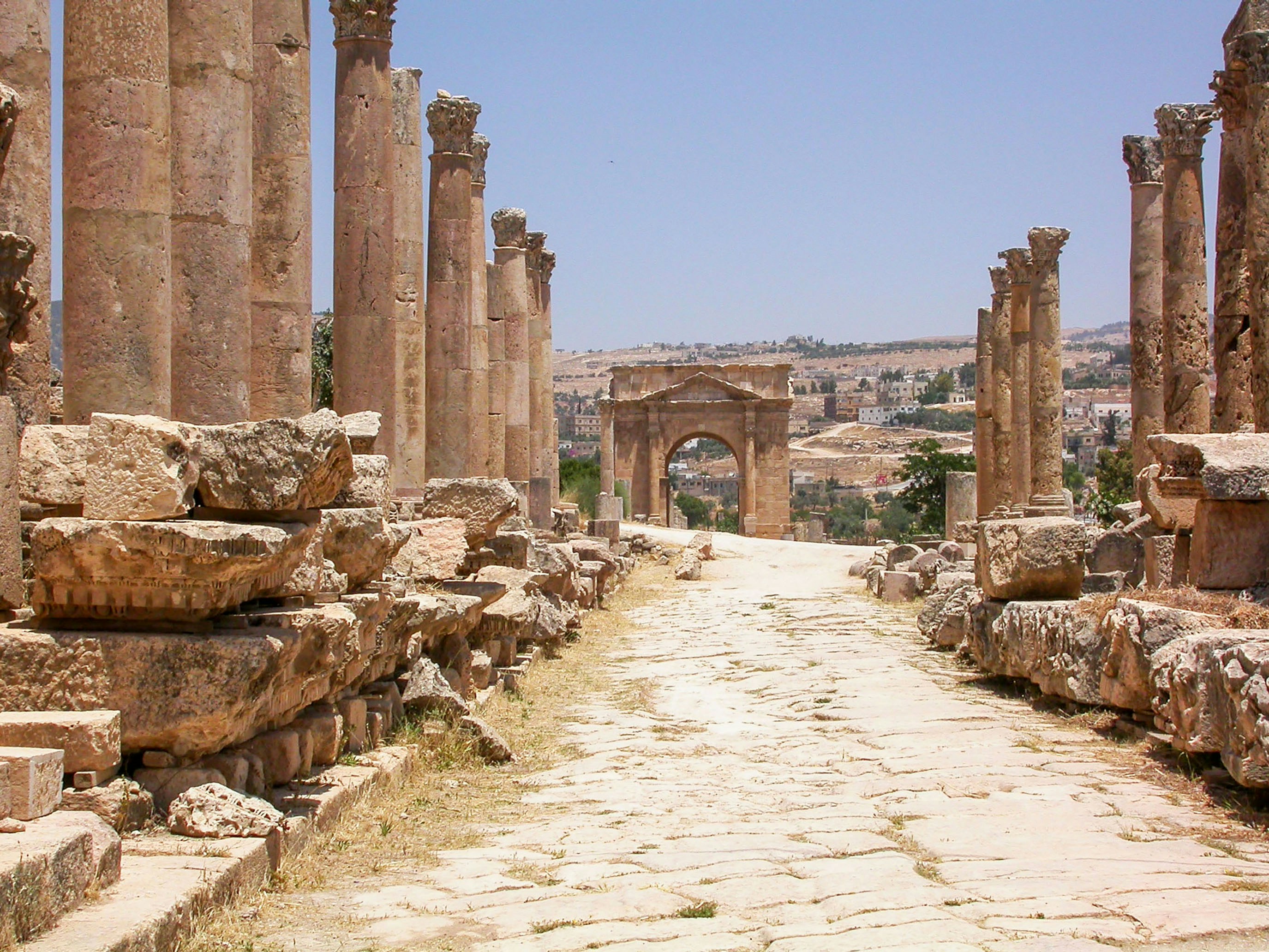 Stone Avenue of Ruins: Framed Archway at the End of the Colonnaded Path