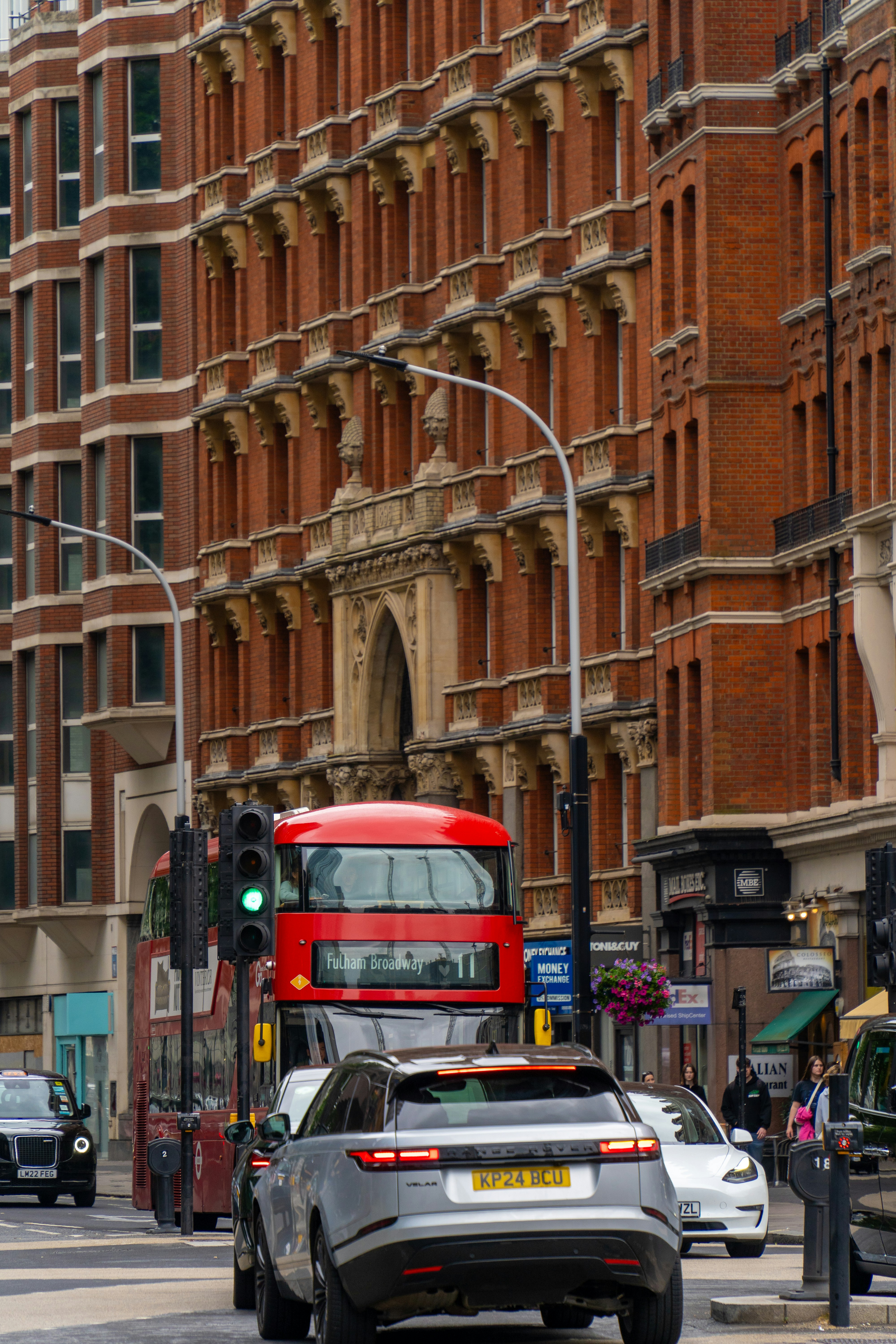 Red Double-Decker in a Stone-Credited City Corridor