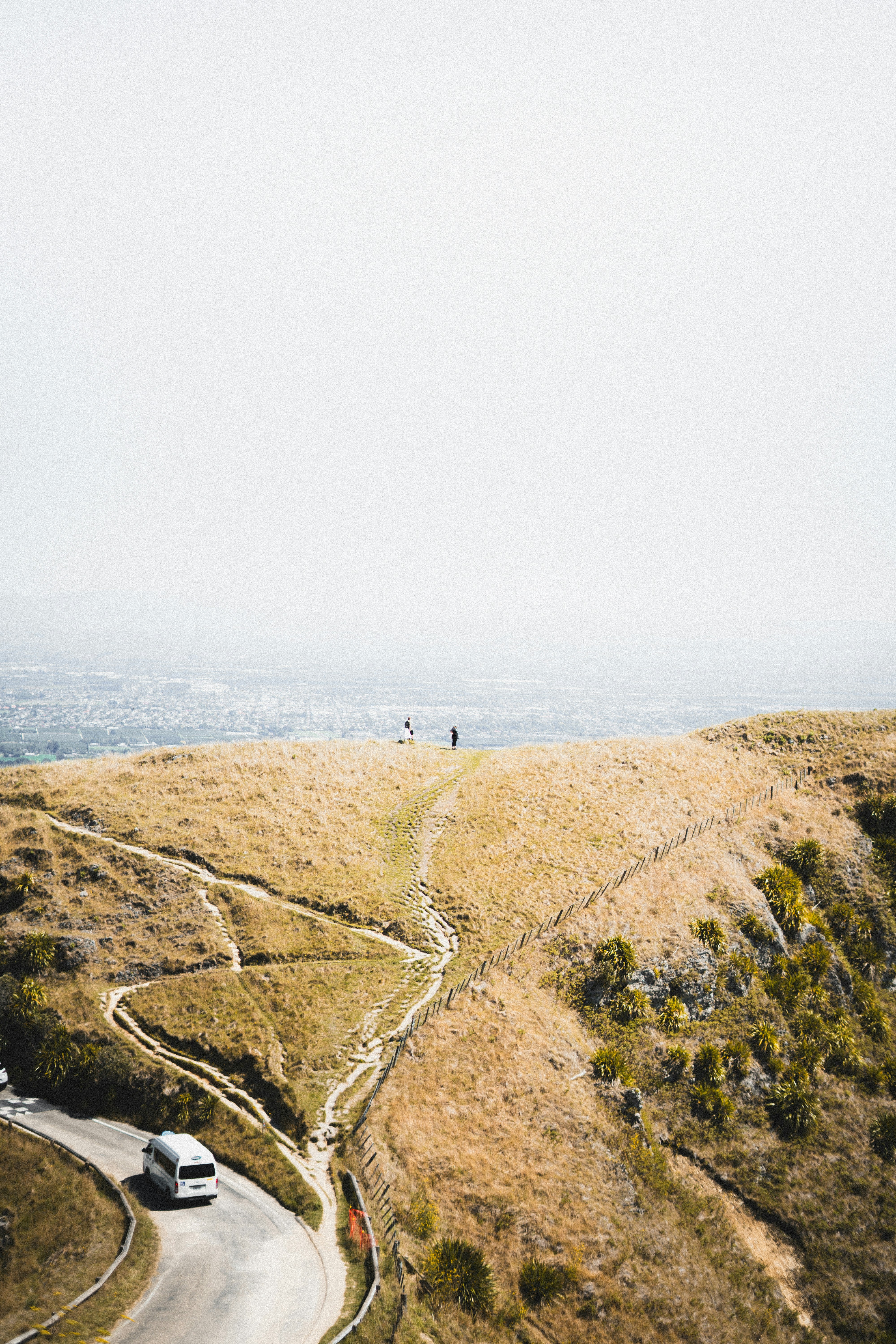Hike to the Horizon: Two Figures on a Parched Ridge Overlooking a Valley
