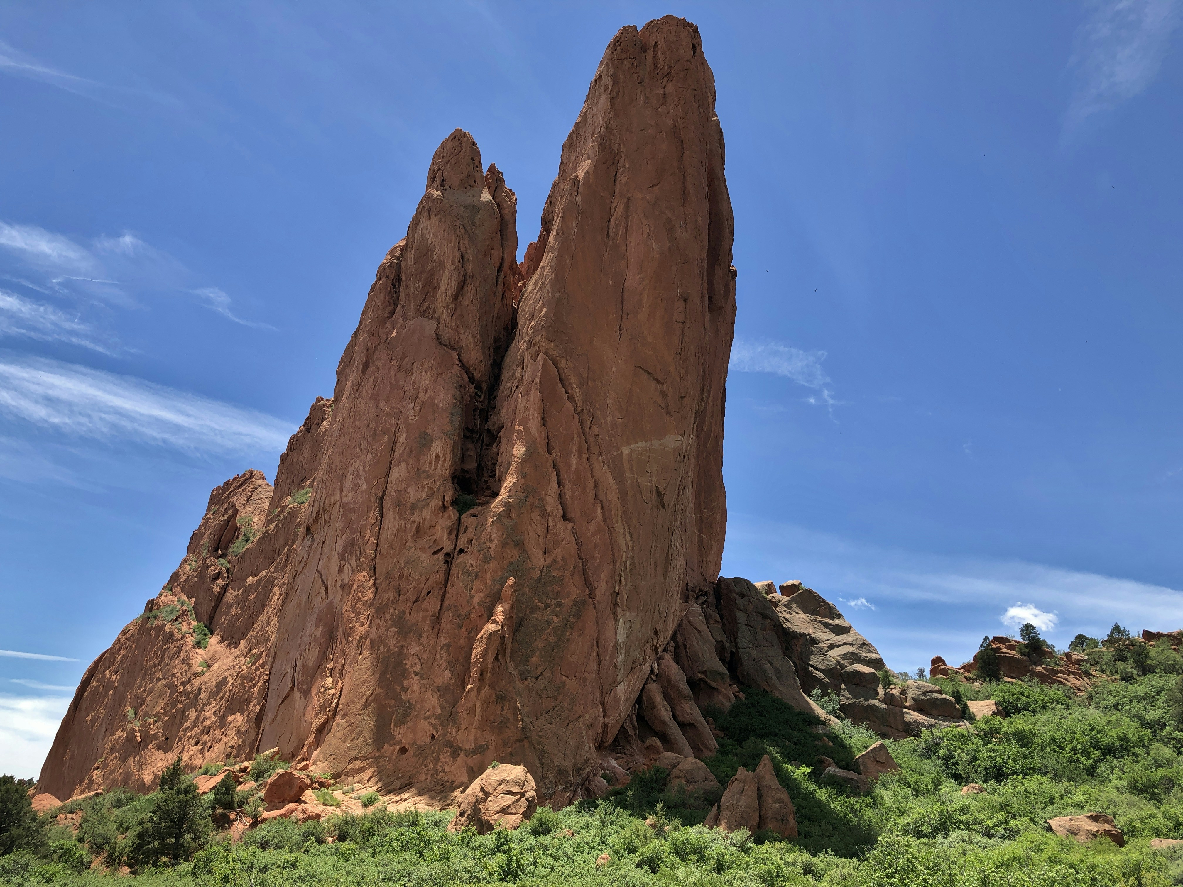 Twin Spire ascent: jagged red rock towers against a blue desert sky